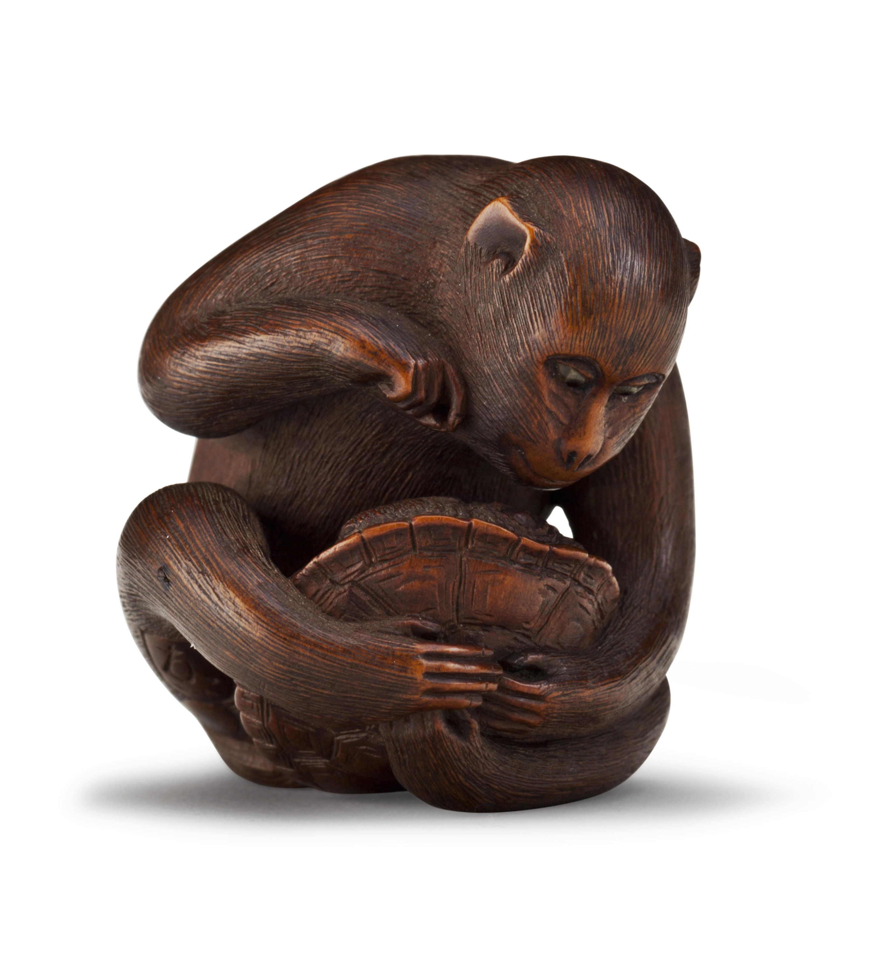 SIGNED TOMOKAZU, EDO PERIOD (19TH CENTURY), A carved wood netsuke of a ...
