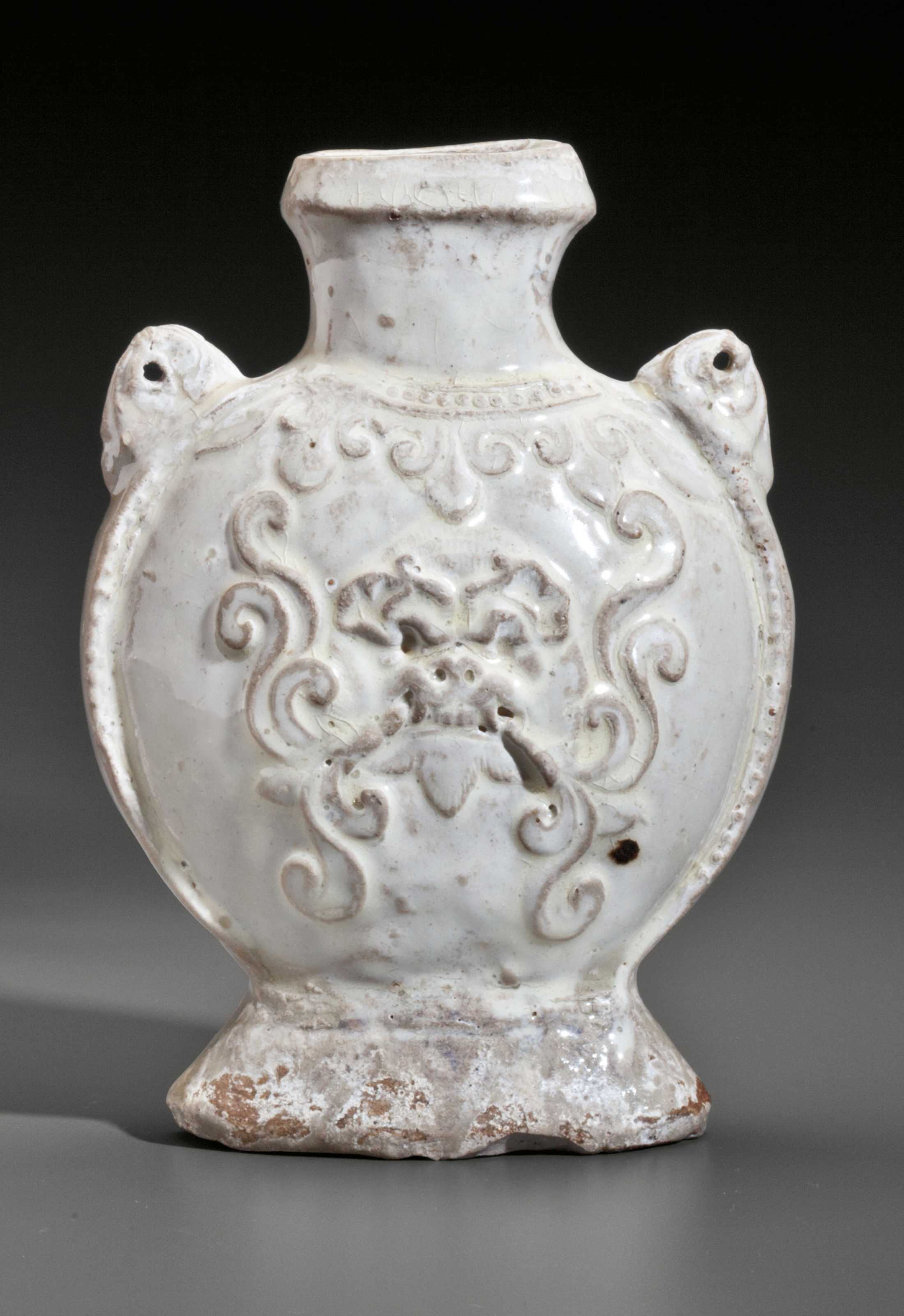 A RARE WHITE-GLAZED POTTERY FLASK, CHINA, NORTHERN QI DYNASTY (AD 550 ...