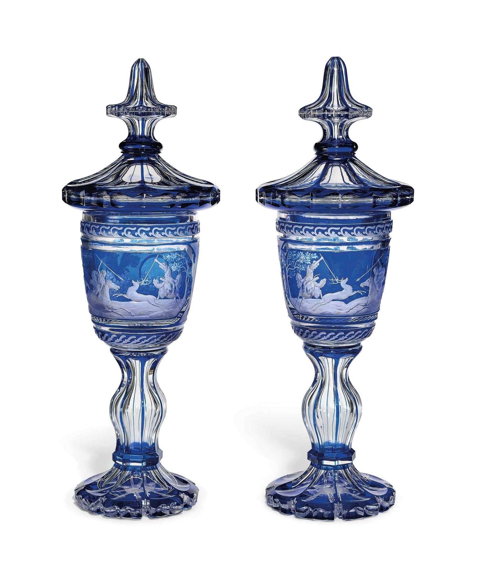 A PAIR OF LARGE BOHEMIAN BLUE OVERLAY ENGRAVED GLASS GOBLETS AND COVERS ...