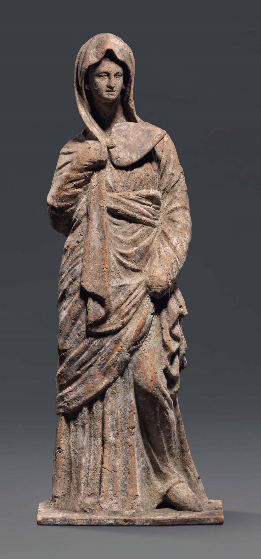 A GREEK TERRACOTTA FEMALE FIGURE, TANAGRA, HELLENISTIC PERIOD, CIRCA ...