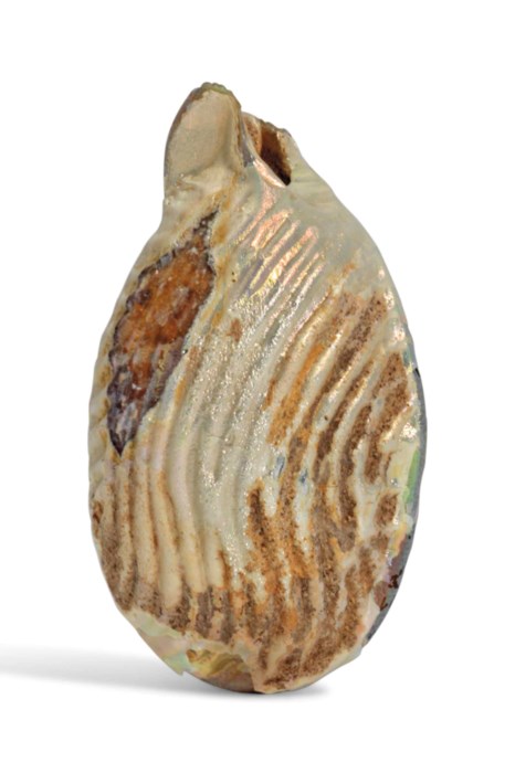 A ROMAN BROWN GLASS SHELL-SHAPED BOTTLE, CIRCA 1ST-2ND CENTURY A.D ...