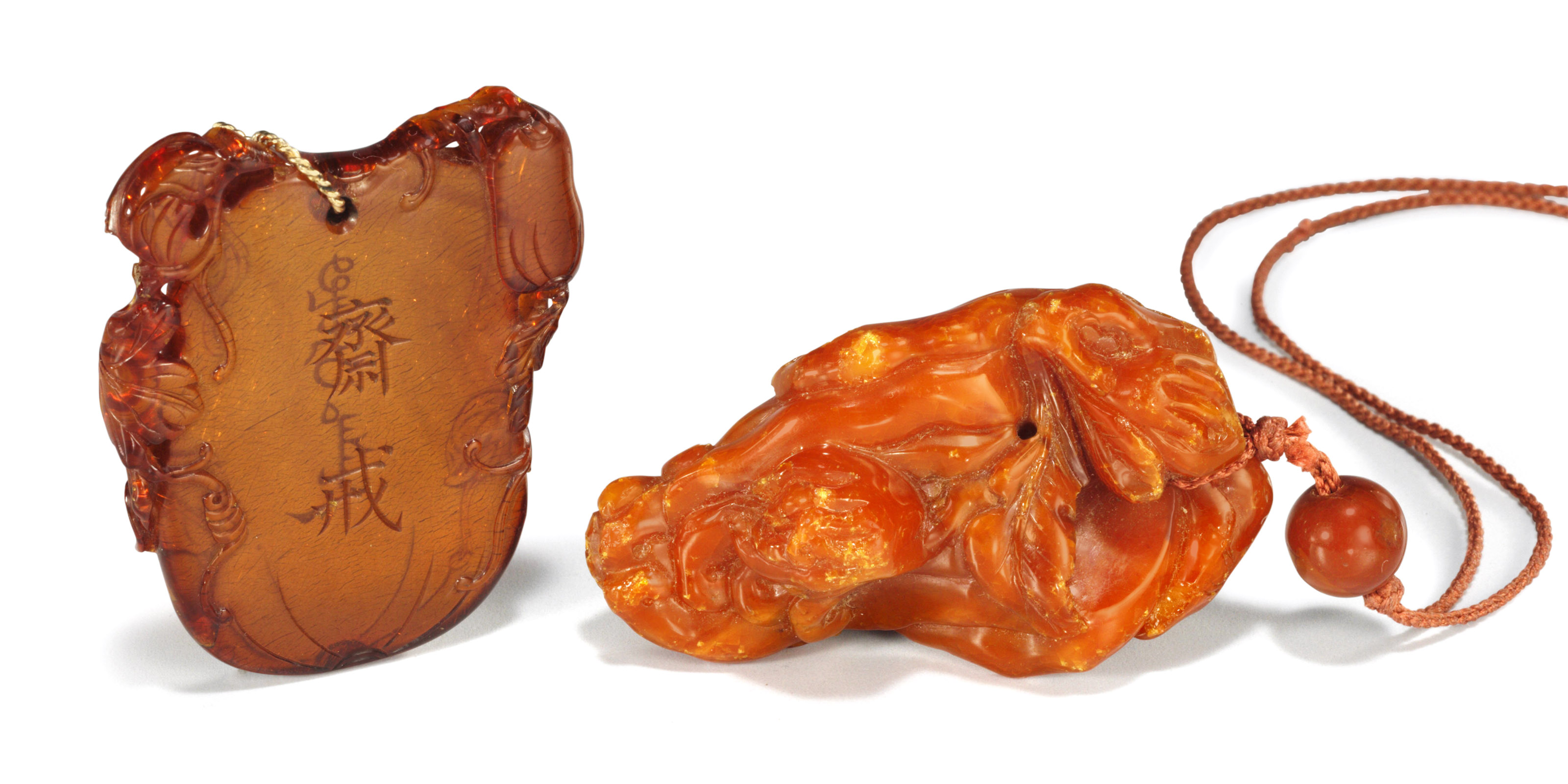 A CARVED AMBER PENDANT AND AN AMBER PLAQUE, CHINA, 18TH-19TH CENTURY ...