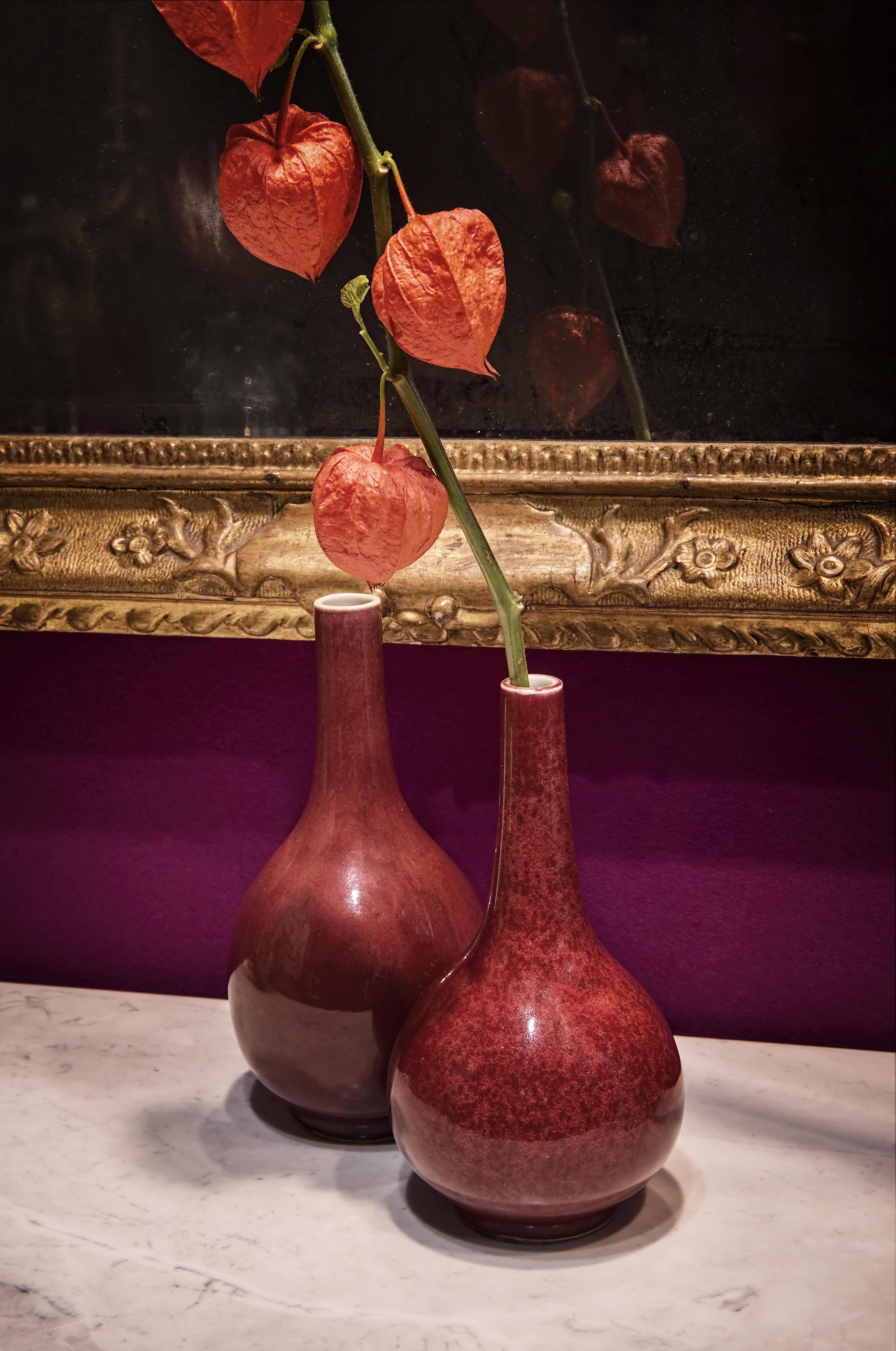 TWO SMALL COPPER-RED-GLAZED BOTTLE VASES, 20TH CENTURY | Christie’s