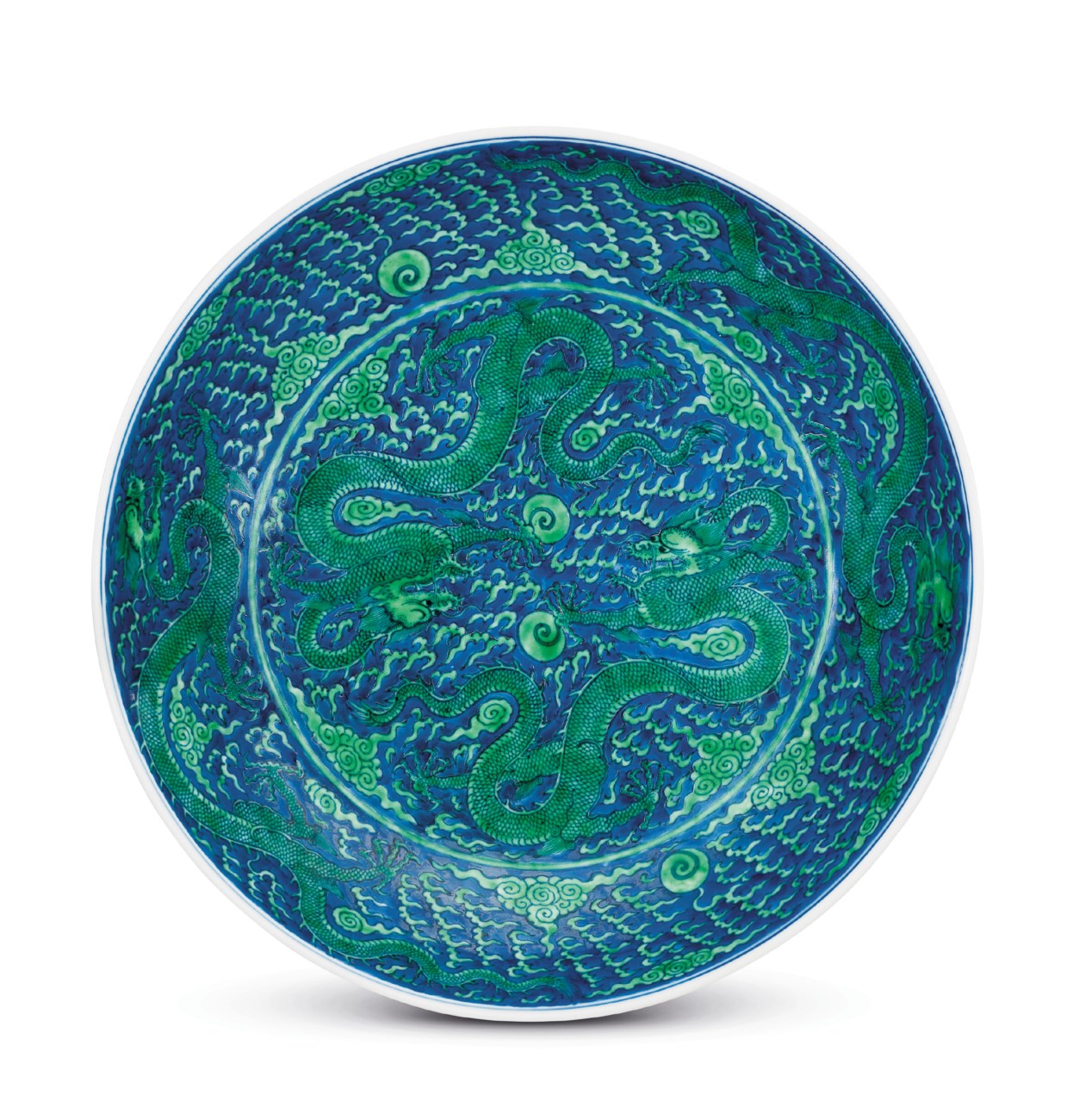 A RARE LARGE UNDERGLAZE-BLUE GROUND GREEN-ENAMELLED 'DRAGON" DISH ...