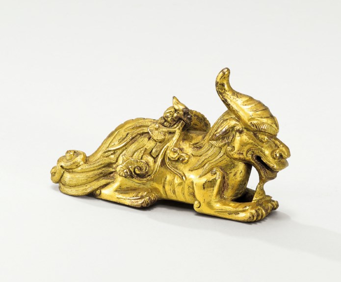 A GILT-BRONZE LUDUAN-FORM PAPERWEIGHT, MING DYNASTY (1368-1644 ...