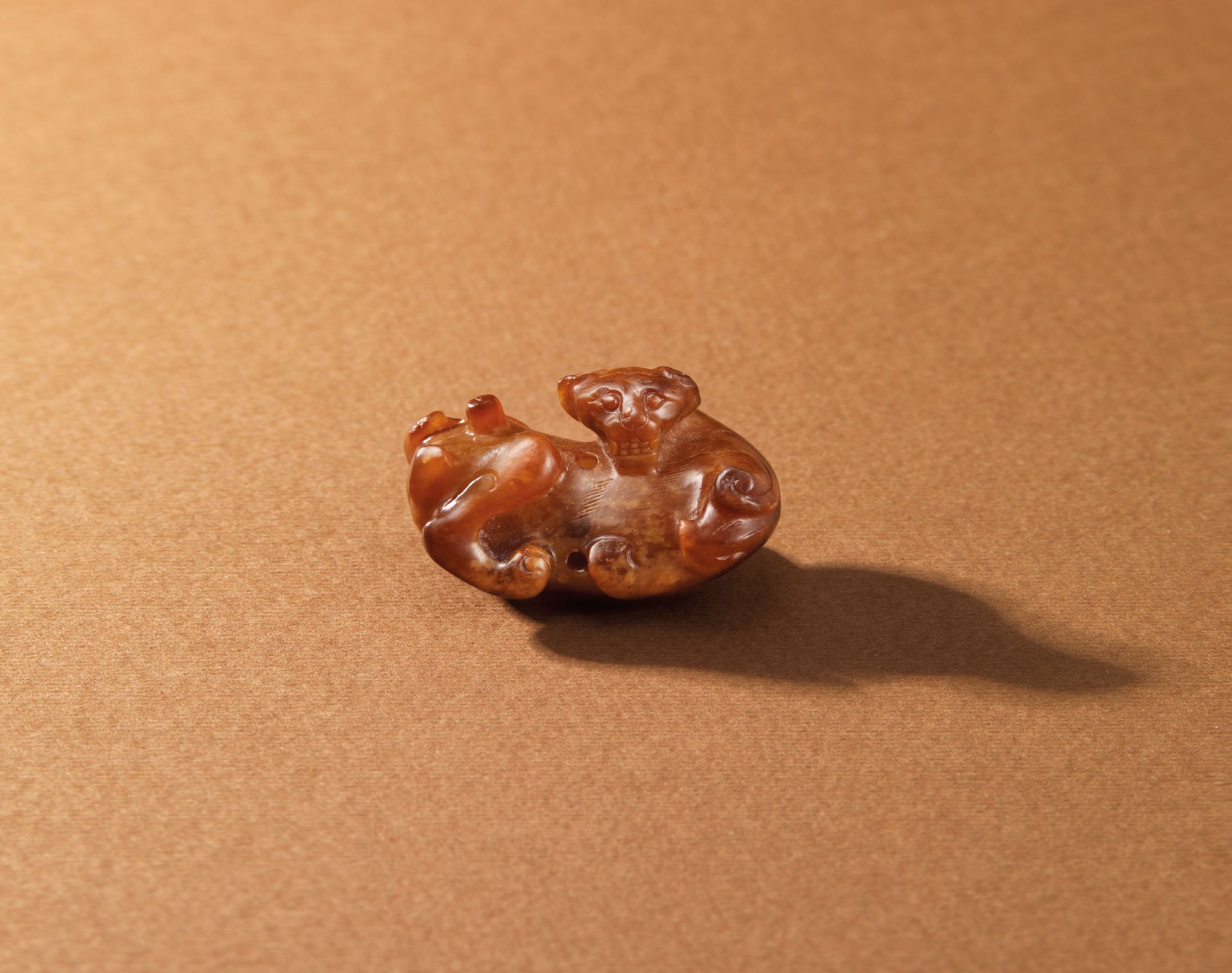 A RUSSET JADE CARVING OF A MYTHICAL BEAST, BIXIE, SIX DYNASTIES (220 ...