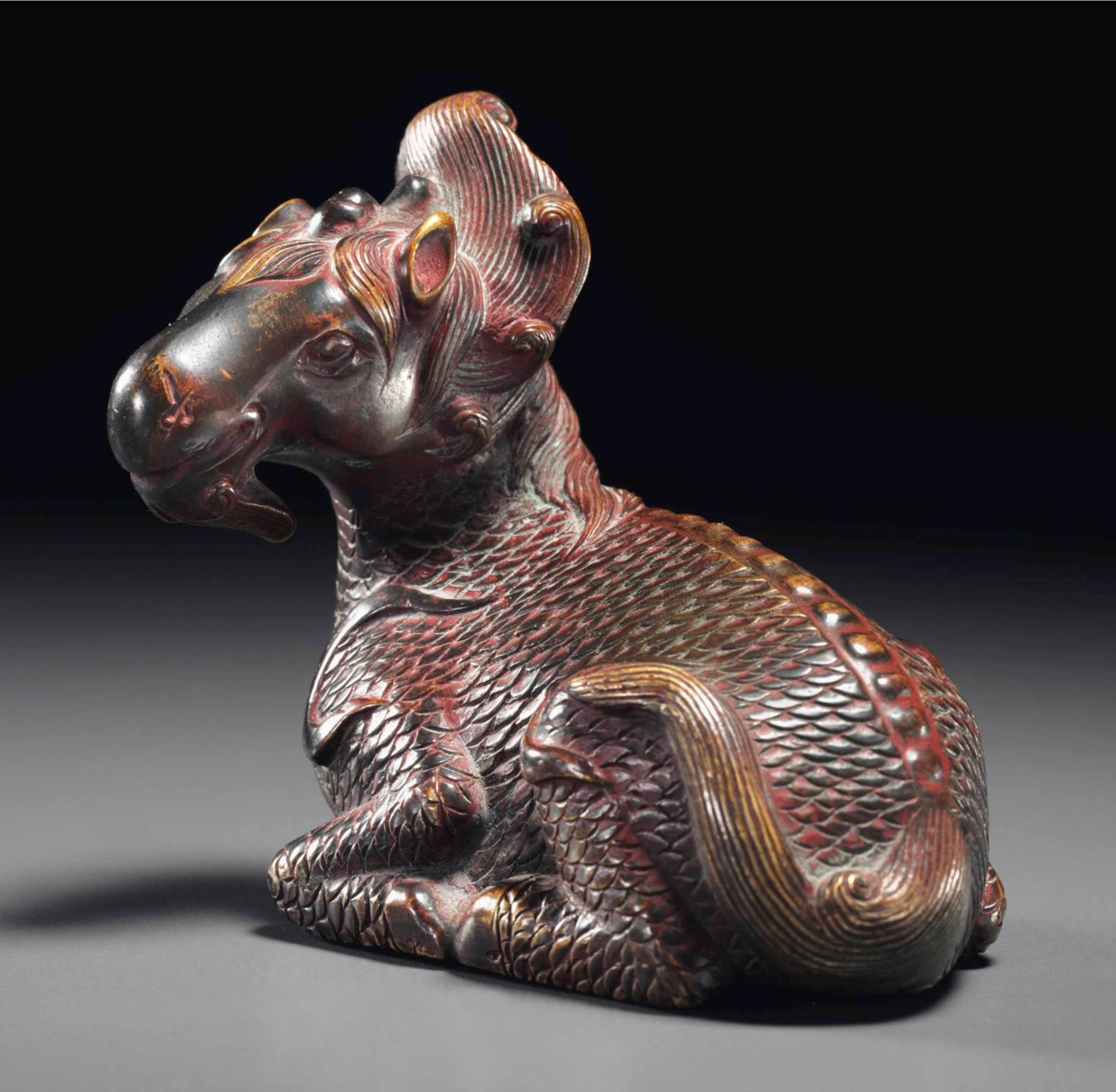 A FINELY CAST BRONZE FIGURE OF A MYTHICAL BEAST, LATE MING DYNASTY ...