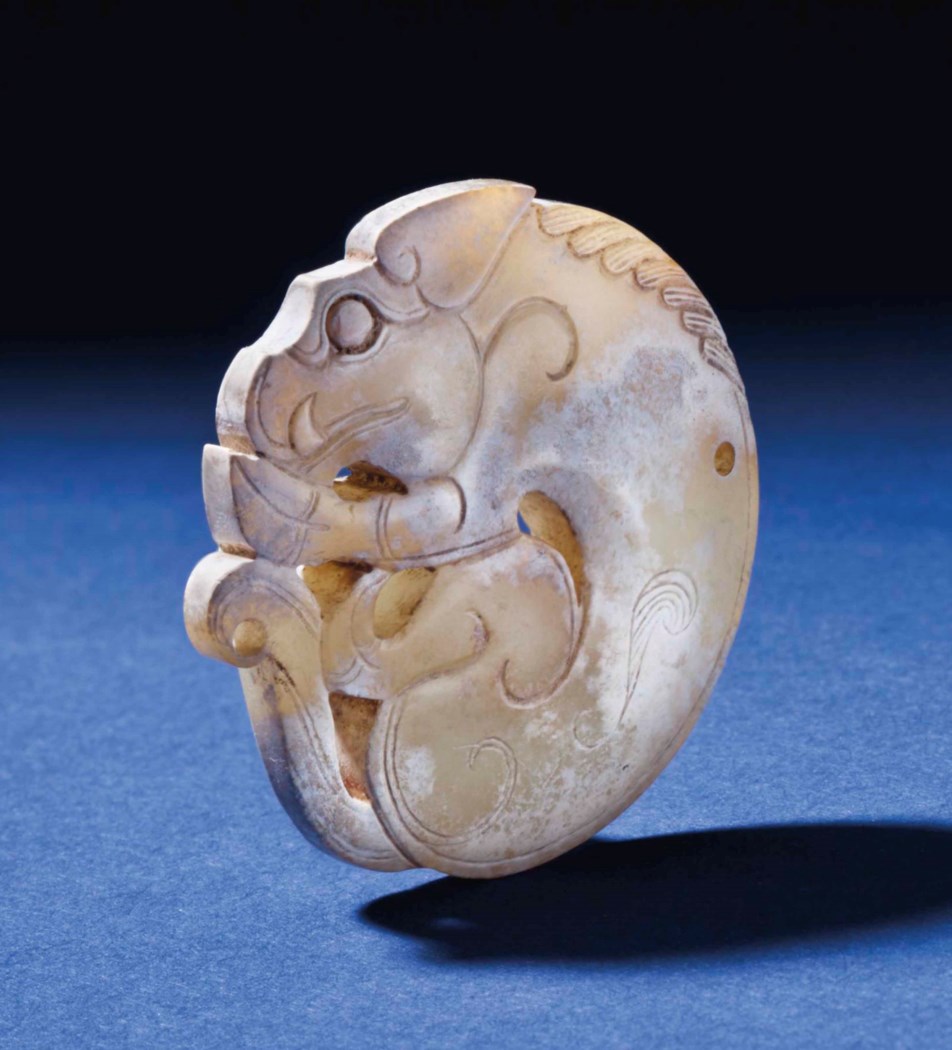 A SMALL SUPERBLY CARVED PALE OLIVE-WHITE JADE BIXIE PENDANT, HAN ...