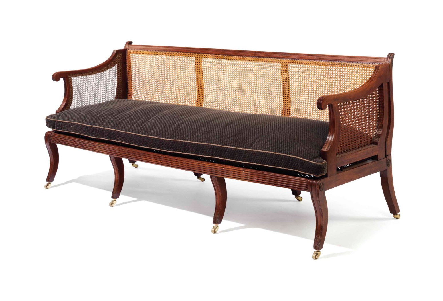 A REGENCY MAHOGANY AND CANED SETTEE, CIRCA 1810 | Christie's