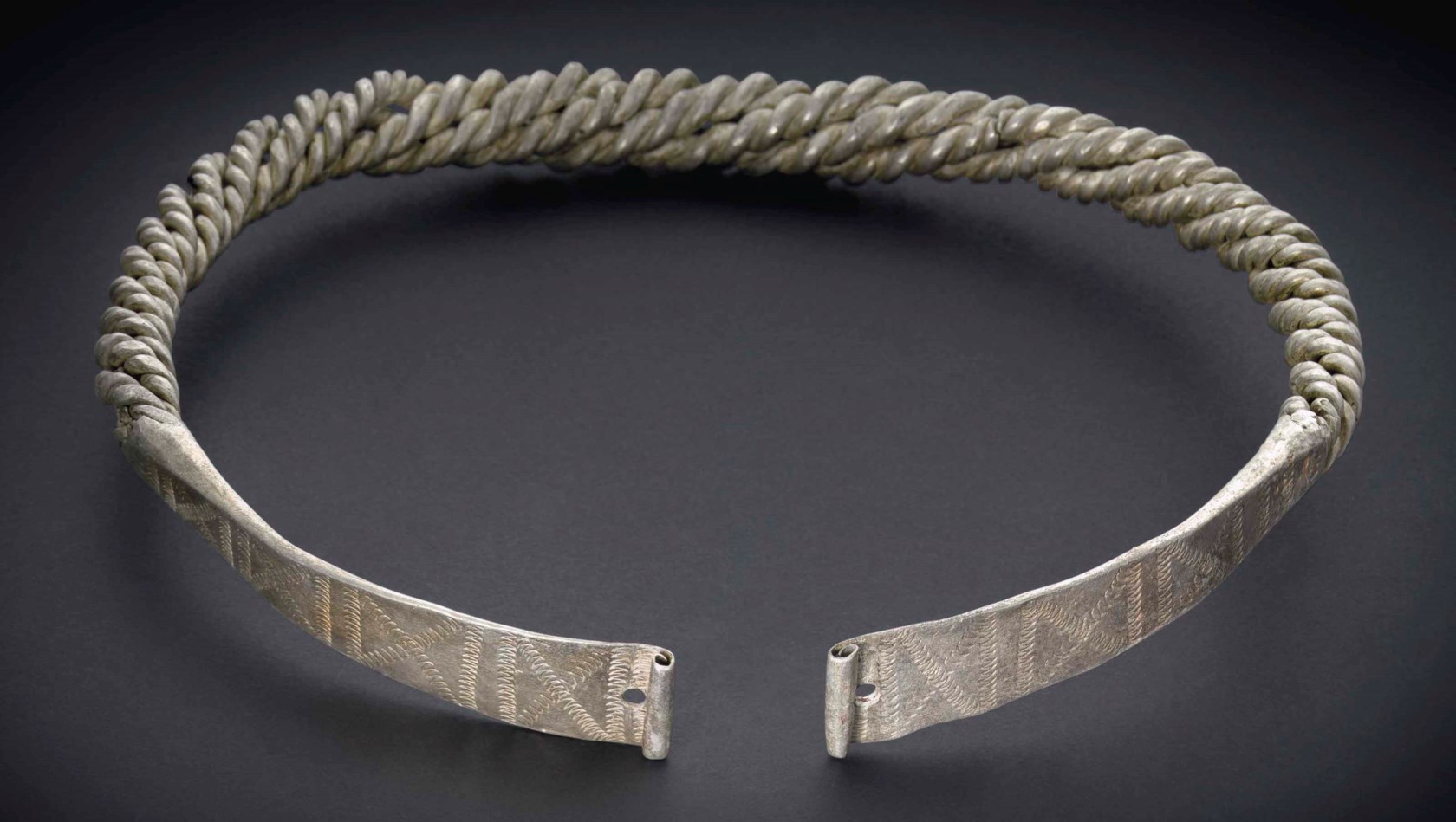 A VIKING SILVER BRAIDED TORQUE WITH INCISED TERMINALS, CIRCA 10TH-11TH ...