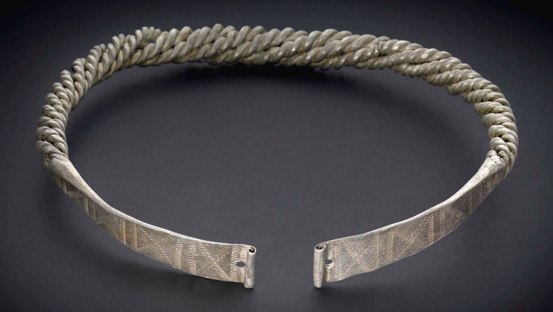 A VIKING SILVER BRAIDED TORQUE WITH INCISED TERMINALS, CIRCA 10TH-11TH ...