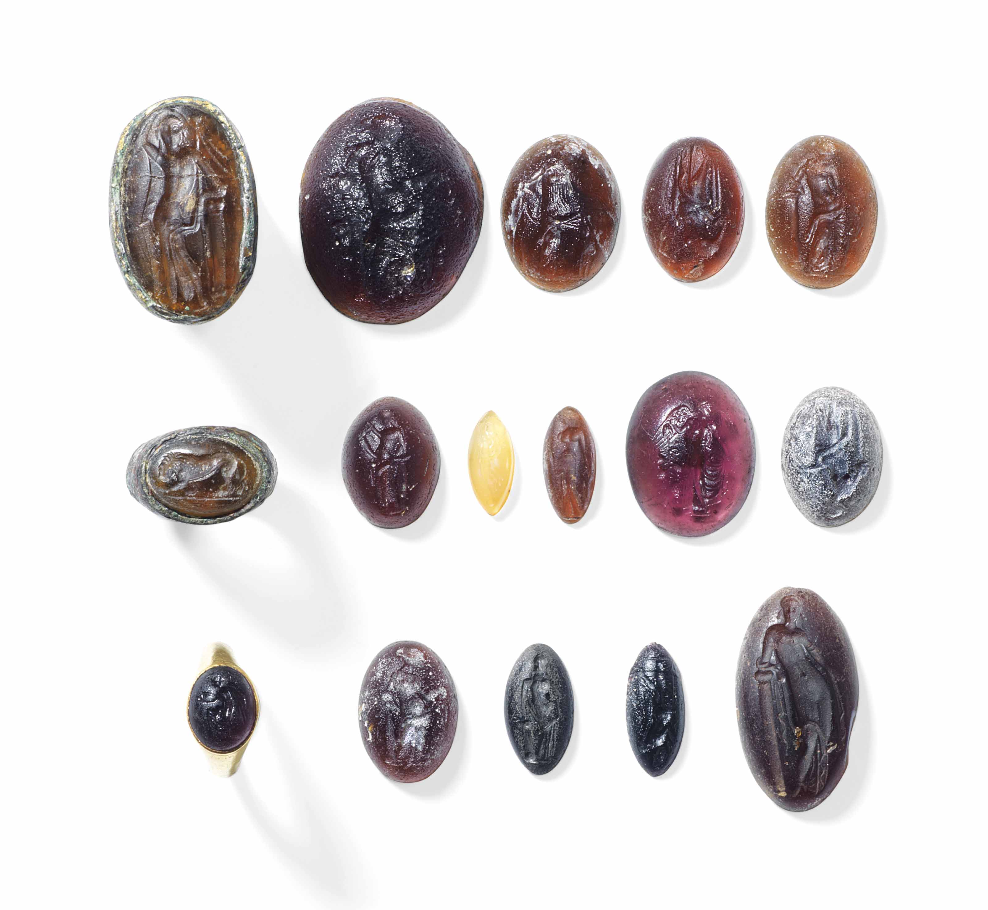 TWELVE GREEK GLASS INTAGLIOS, A CARNELIAN INTAGLIO AND THREE GLASS ...
