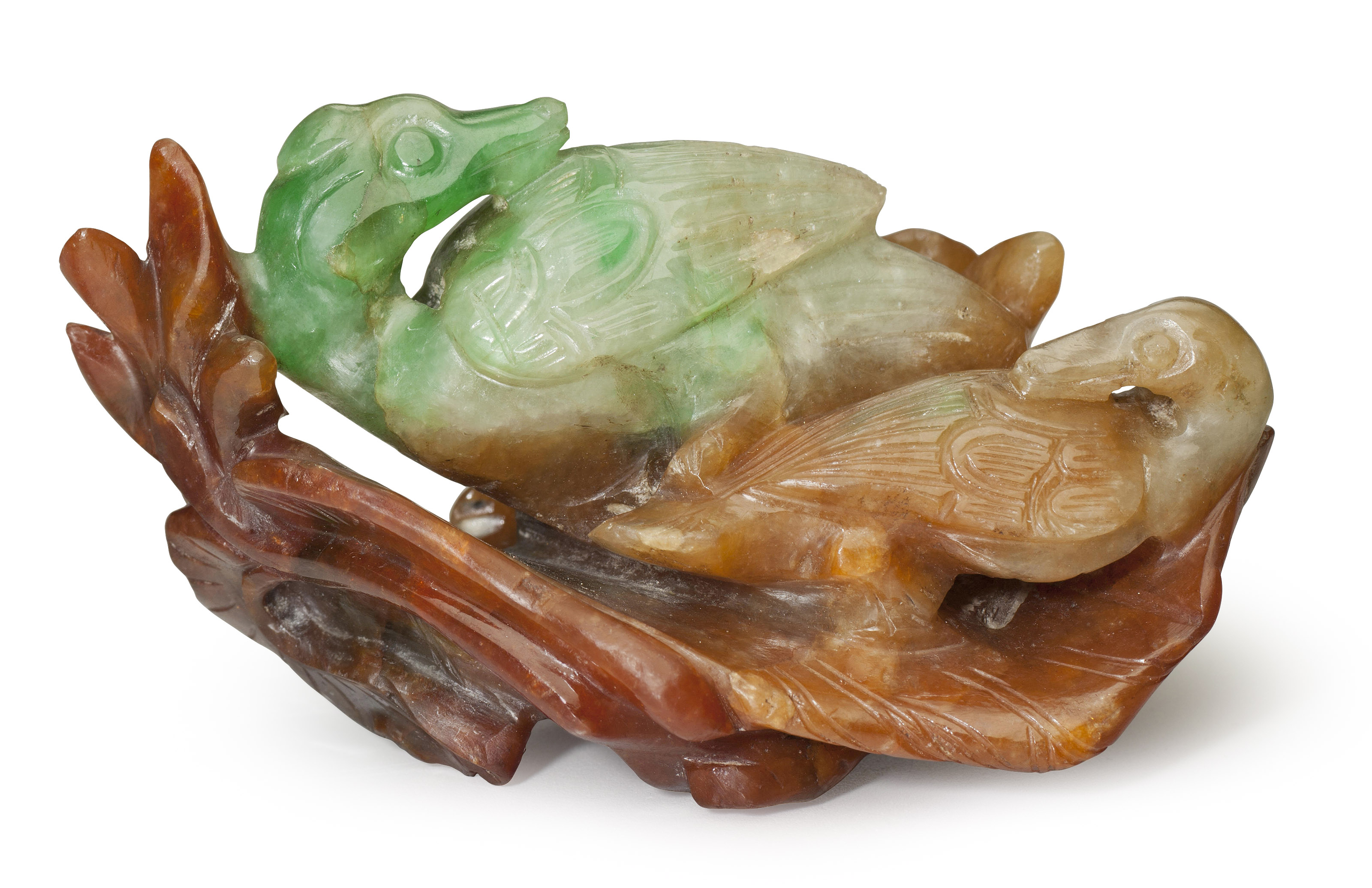 A GREEN AND BROWN JADEITE CARVING OF TWO DUCKS, | Christie’s