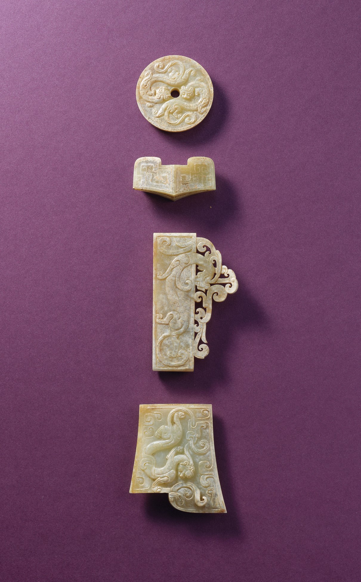 AN IMPORTANT SET OF THREE JADE ‘CHILONG’ SWORD FITTINGS AND A JADE ...