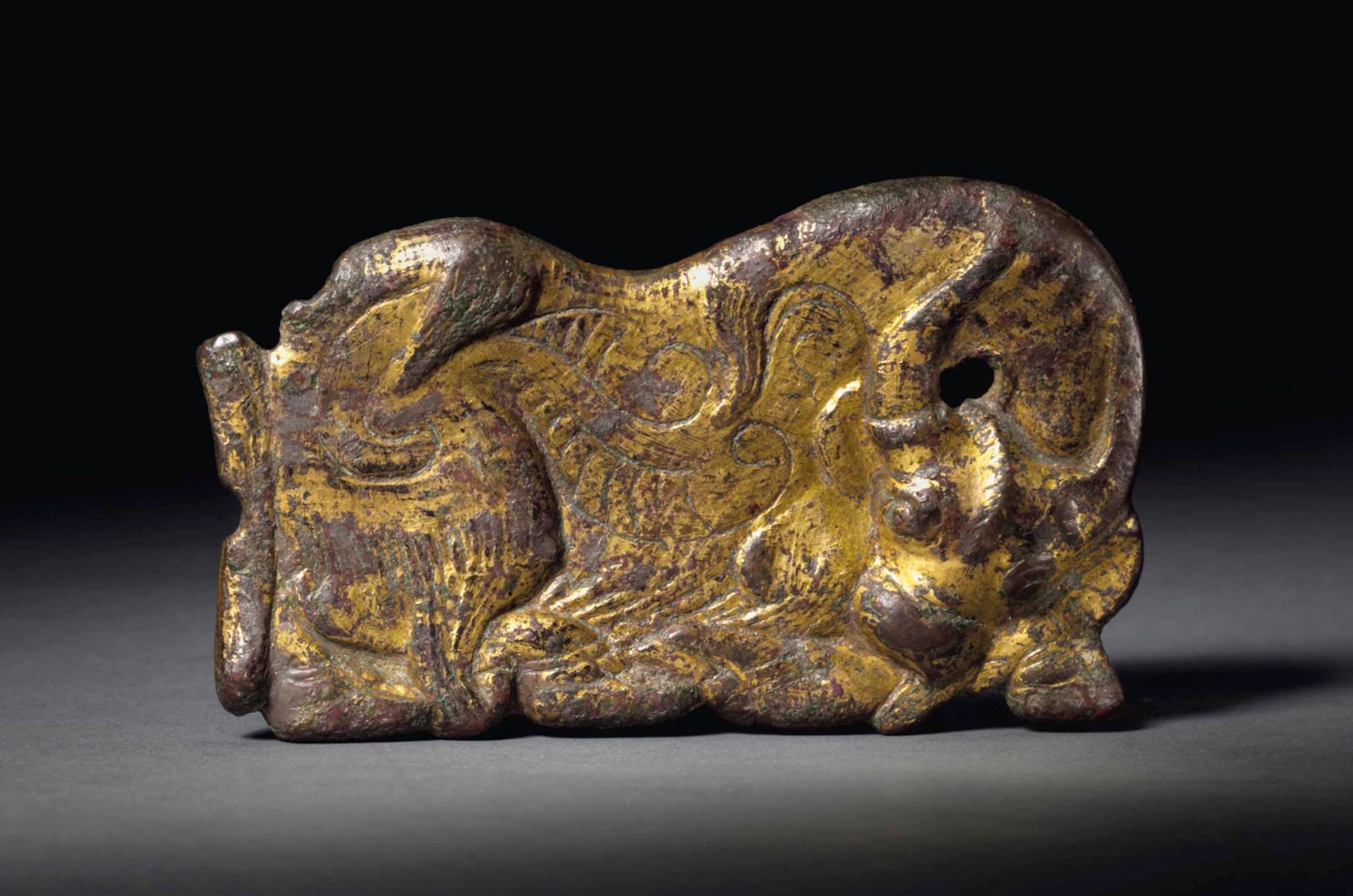 A GILT-BRONZE BELT PLAQUE IN THE SHAPE OF A YAK, NORTH CHINA, 3RD-2ND ...