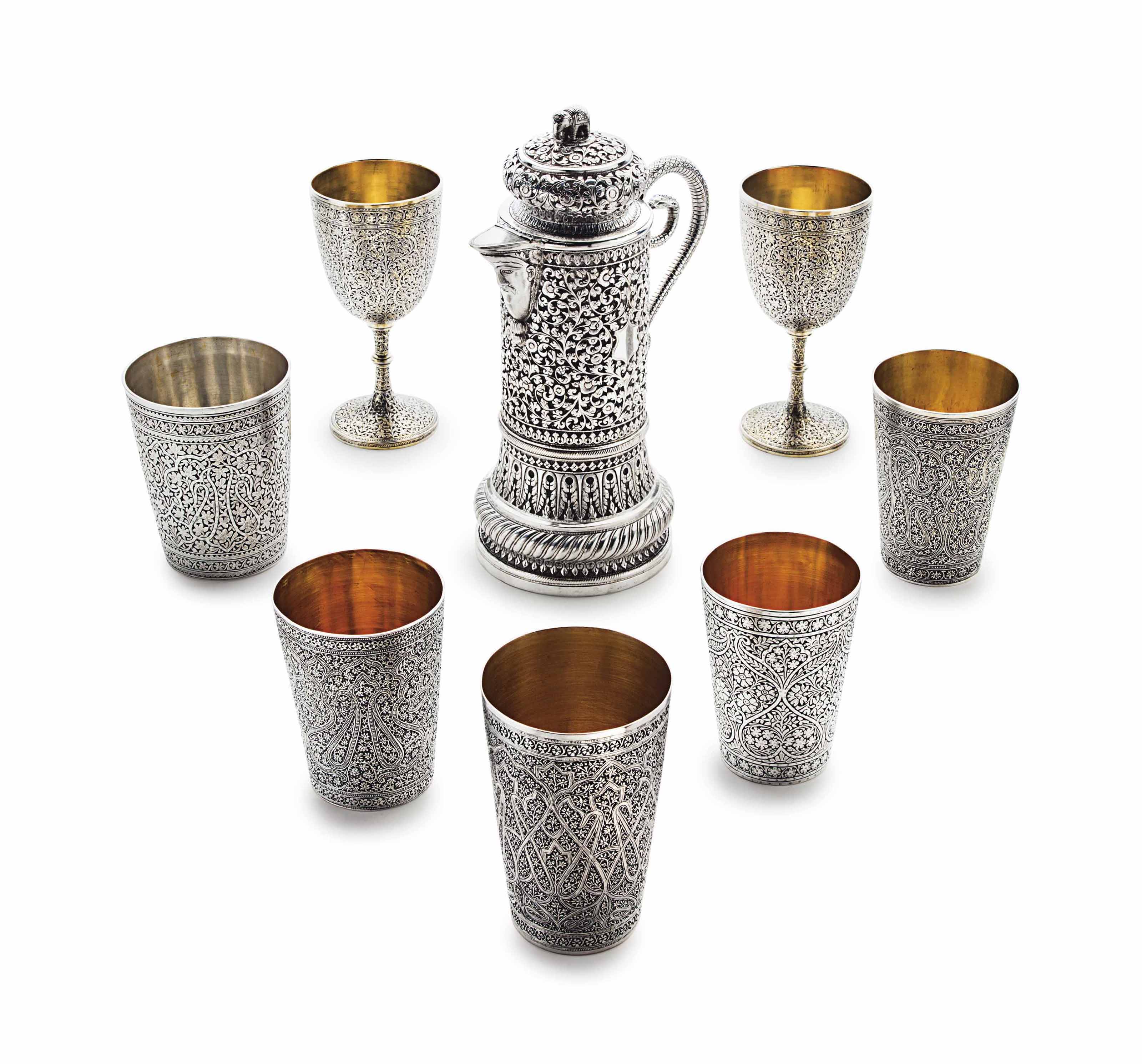 A SILVERED-METAL MATCHED SET OF DRINKING VESSELS