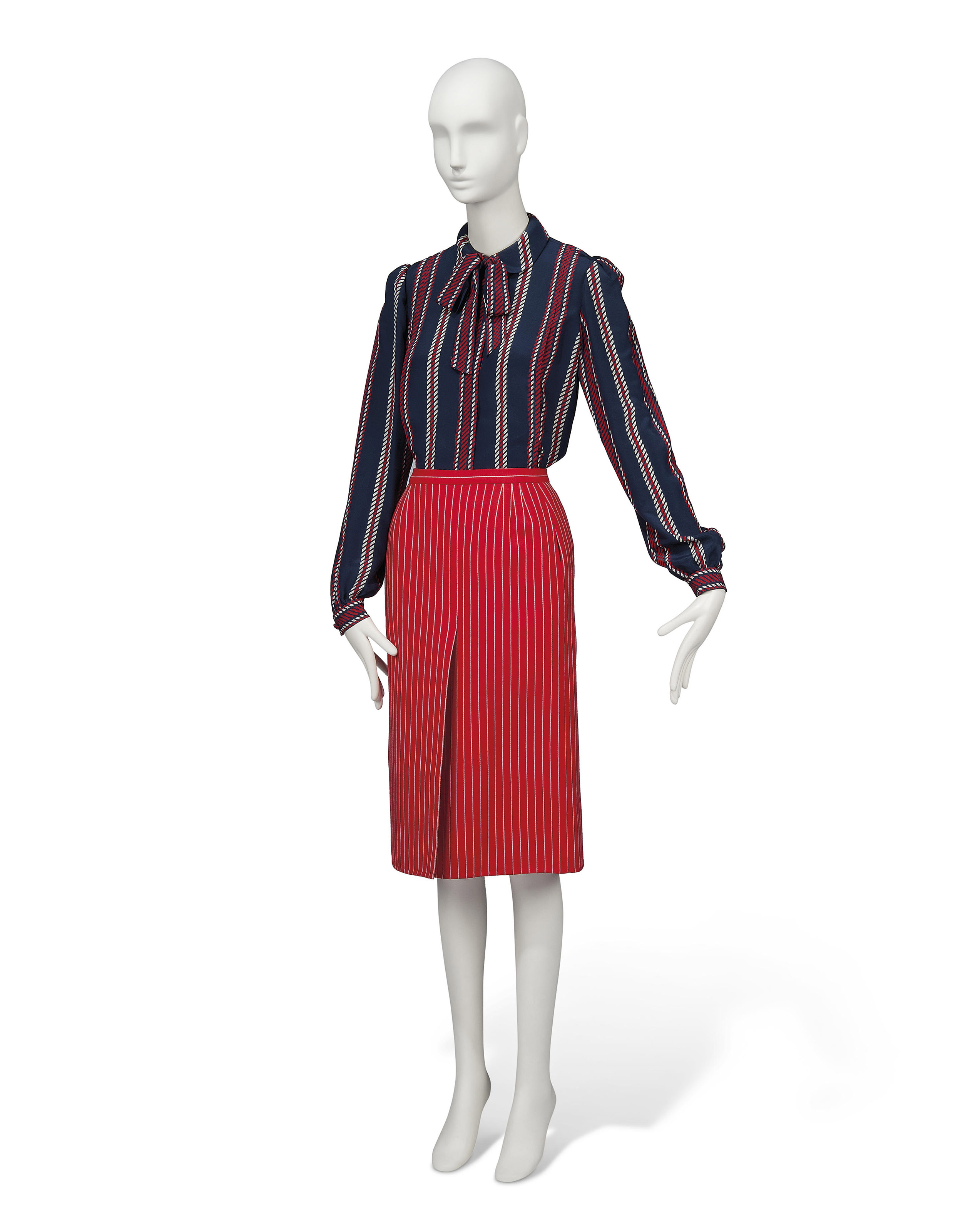 A RED WOOL PINSTRIPED SKIRT, A SILK BLOUSE AND TIE AND ANOTHER SHIRT ...