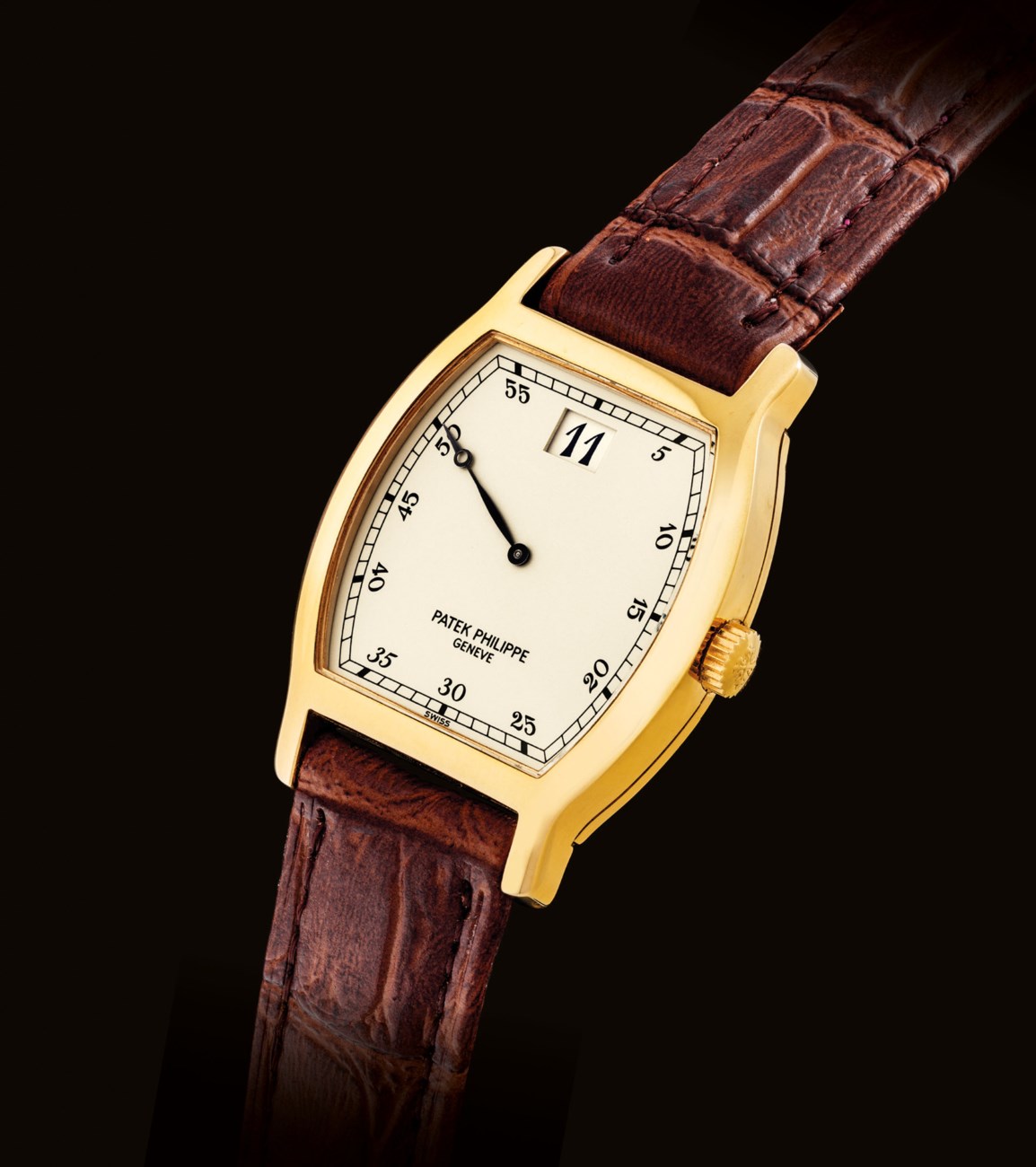 PATEK PHILIPPE. A FINE AND RARE 18K PINK GOLD TONNEAU-SHAPED JUMP HOUR ...