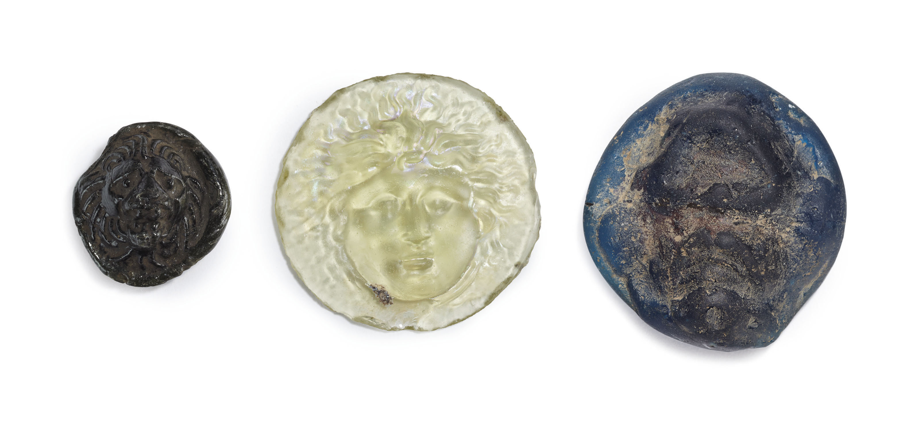 THREE CARTHAGINIAN GLASS HEAD BEADS, CIRCA 6TH-MID 2ND CENTURY B.C ...