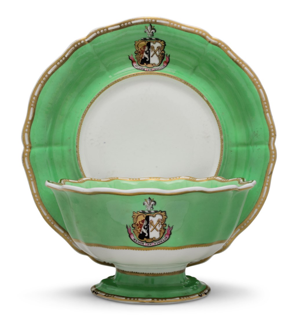 A SPODE FELSPAR PORCELAIN ARMORIAL APPLE-GREEN GROUND BOWL AND STAND ...