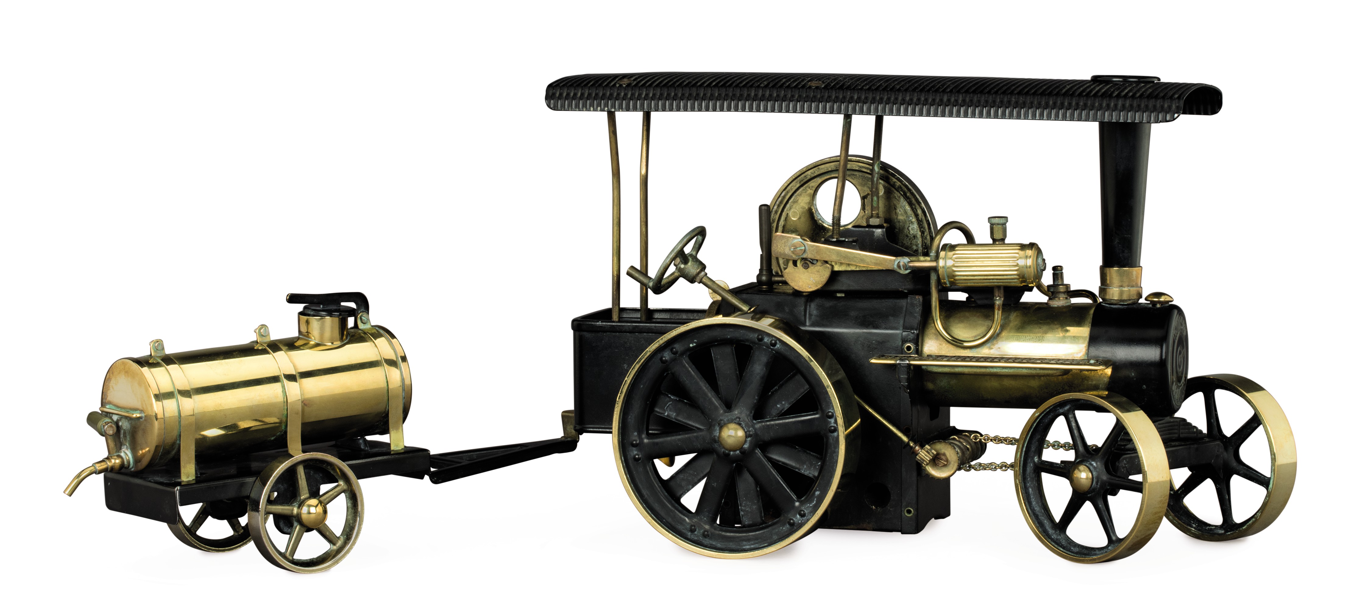 A WILESCO BRASS AND BLACK-PAINTED TIN PLATE STEAM TRACTOR AND WATER ...