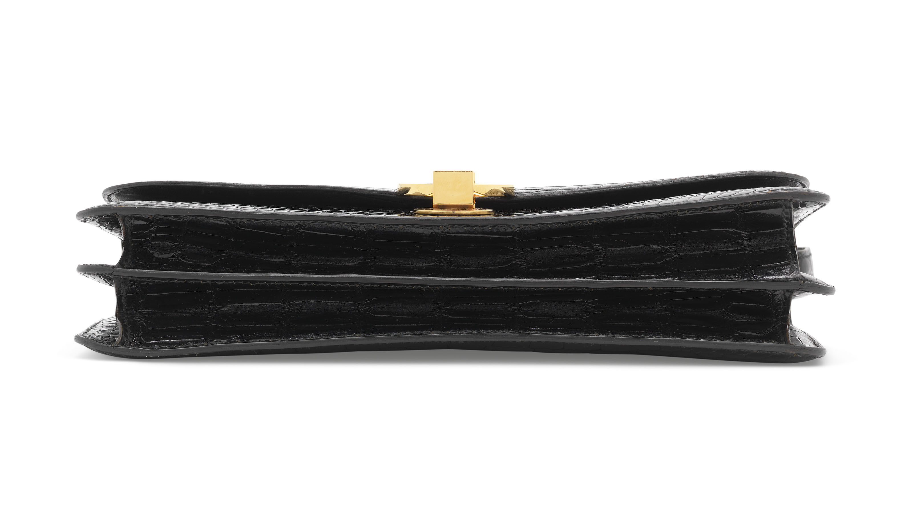 A SHINY BLACK CAIMAN RING BAG WITH GOLD HARDWARE