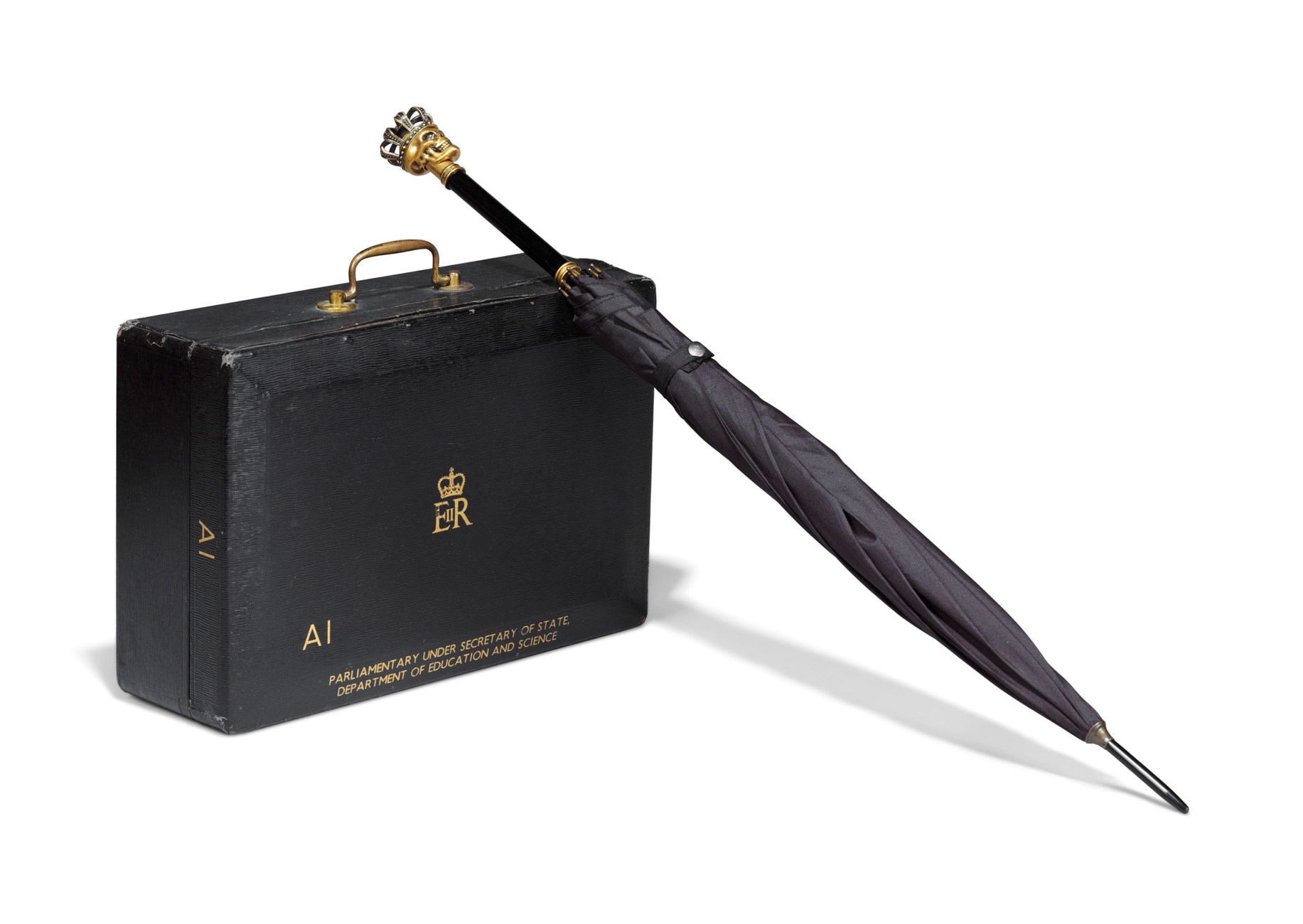 A GILT EMBOSSED AND BLACK LEATHER COVERED MINISTER'S PARLIAMENTARY ...