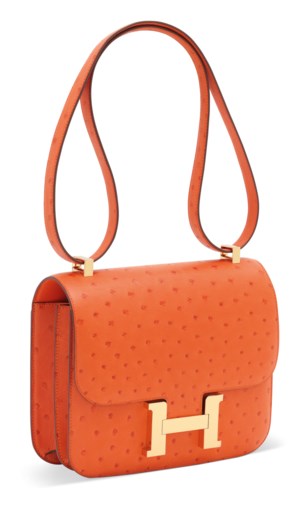 A TANGERINE OSTRICH CONSTANCE 24 WITH GOLD HARDWARE, HERMÈS, 2017 ...