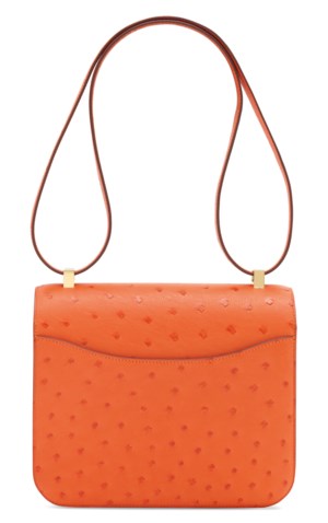 A TANGERINE OSTRICH CONSTANCE 24 WITH GOLD HARDWARE, HERMÈS, 2017 ...