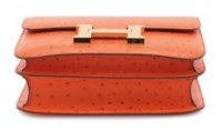 A TANGERINE OSTRICH CONSTANCE 24 WITH GOLD HARDWARE, HERMÈS, 2017 ...