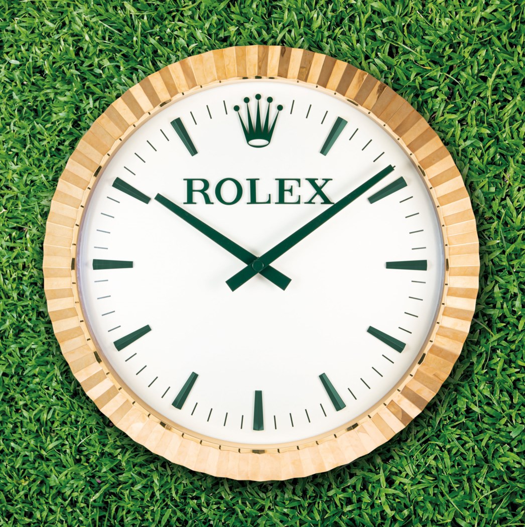 INDUCTA FOR ROLEX. A LARGE AND UNUSUAL GILT METAL QUARTZ WALL CLOCK ...