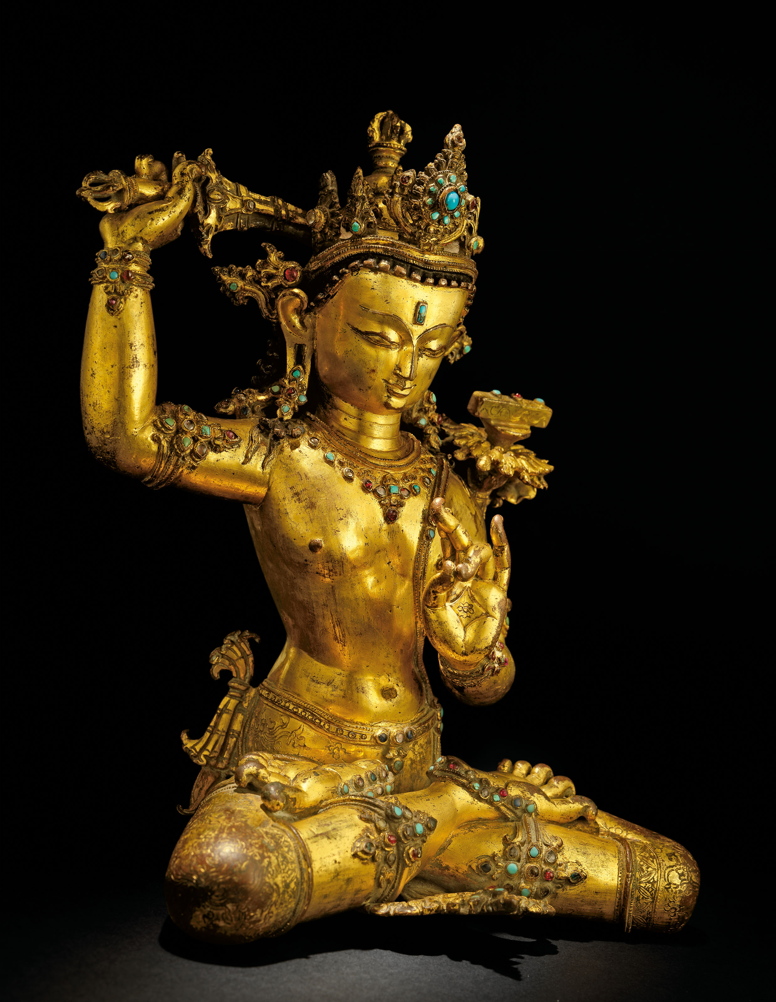A SUPERBLY CAST GILT-COPPER STONE-INLAID SEATED FIGURE OF MANJUSRI