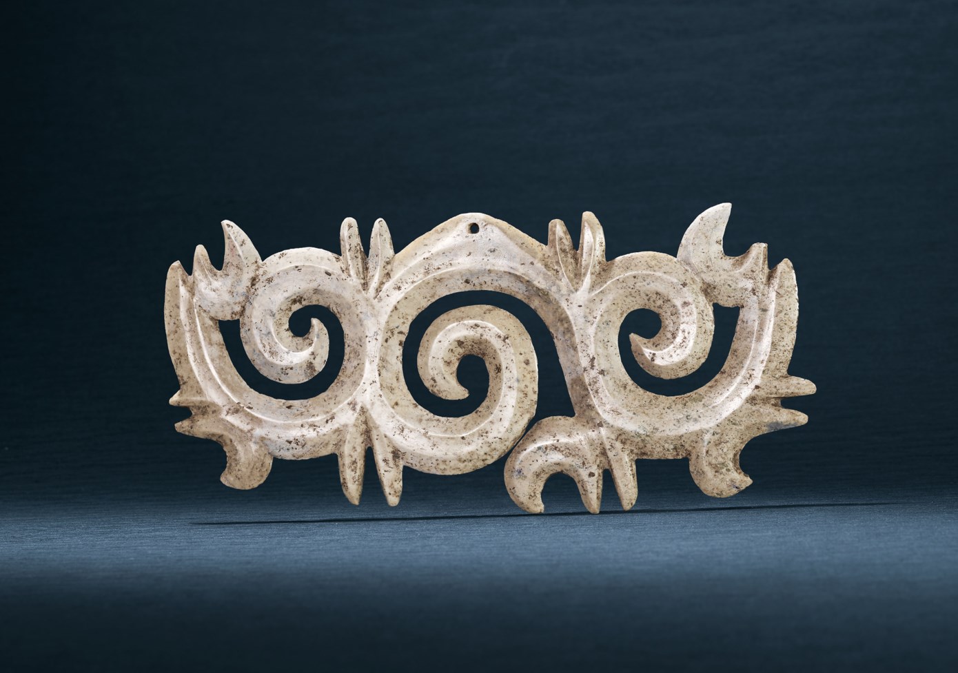 A CELADON JADE ‘CLOUD-SCROLL’ ORNAMENT, HONGSHAN CULTURE, CIRCA 3500 BC ...