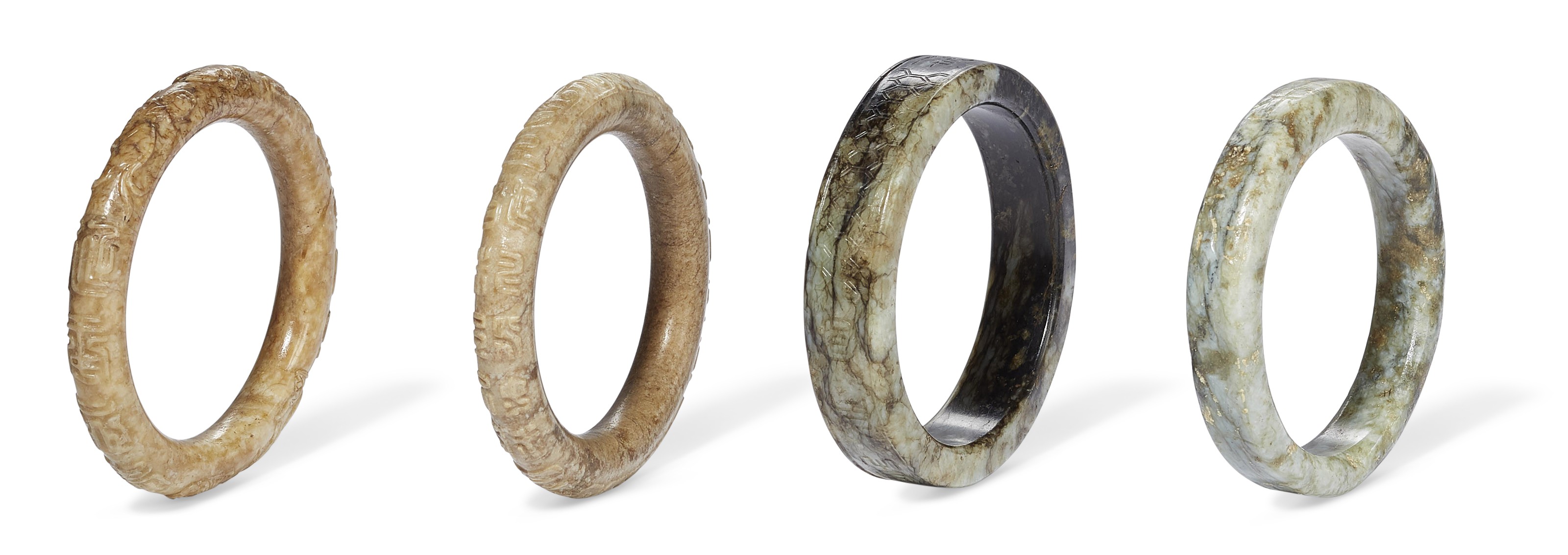 FOUR CARVED ARCHAISTIC JADE BANGLES, QING DYNASTY (1644-1911) | Christie’s