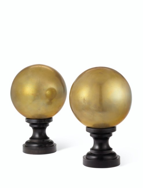 A PAIR OF BRASS SPHERES ON EBONIZED STANDS, SUPPLIED BY RENZO ...