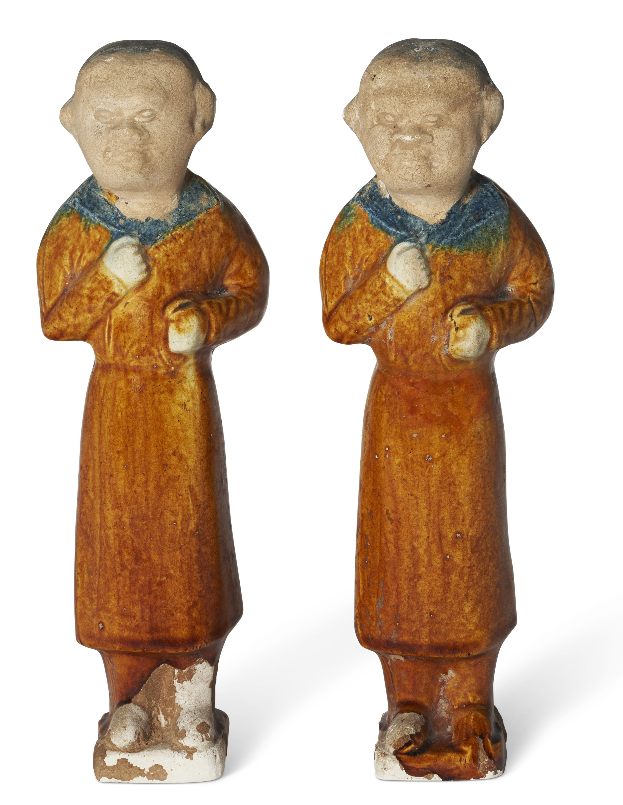 A PAIR OF BLUE AND AMBER-GLAZED POTTERY FIGURES OF FOREIGNERS, TANG ...
