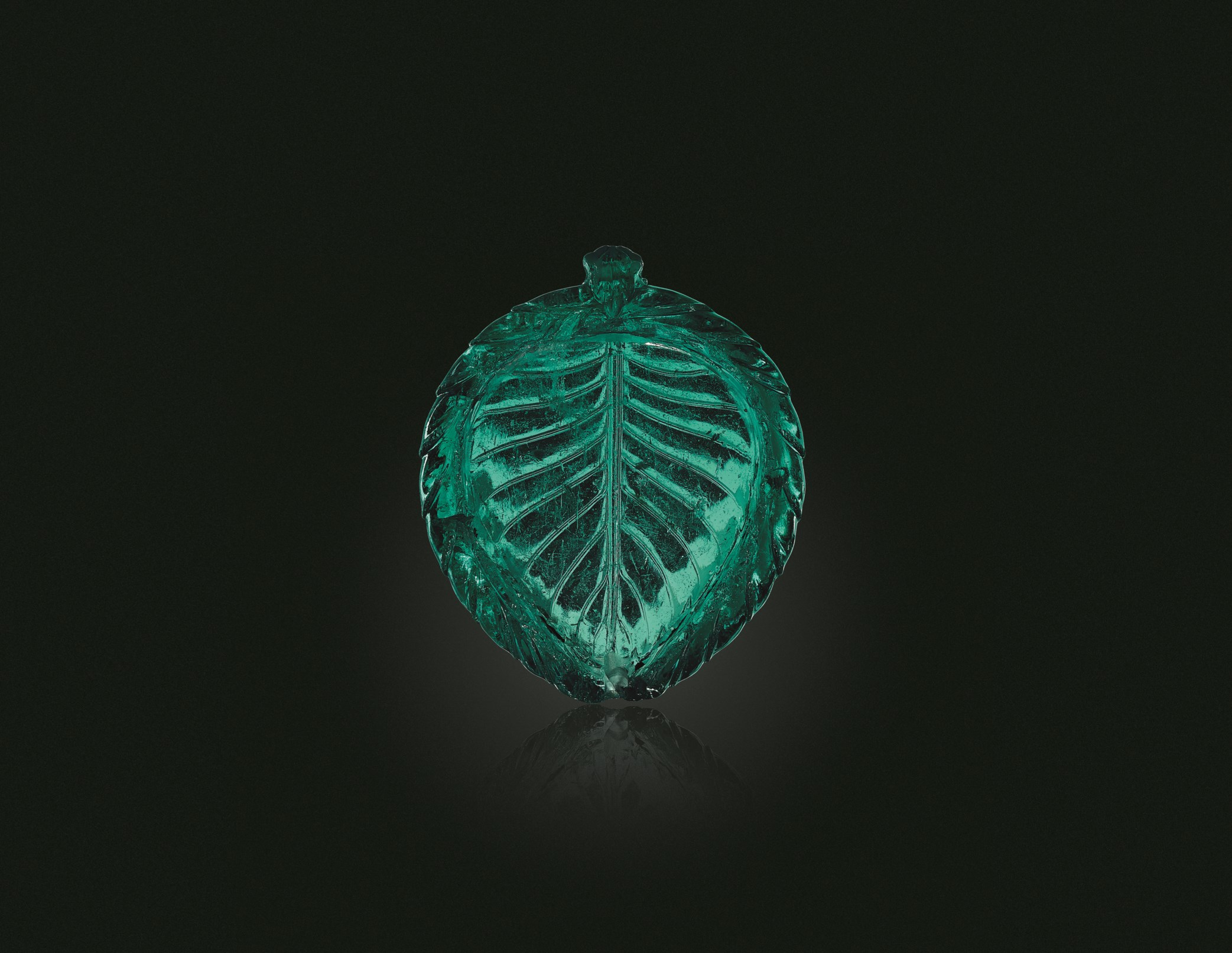 A CARVED EMERALD | Christie's