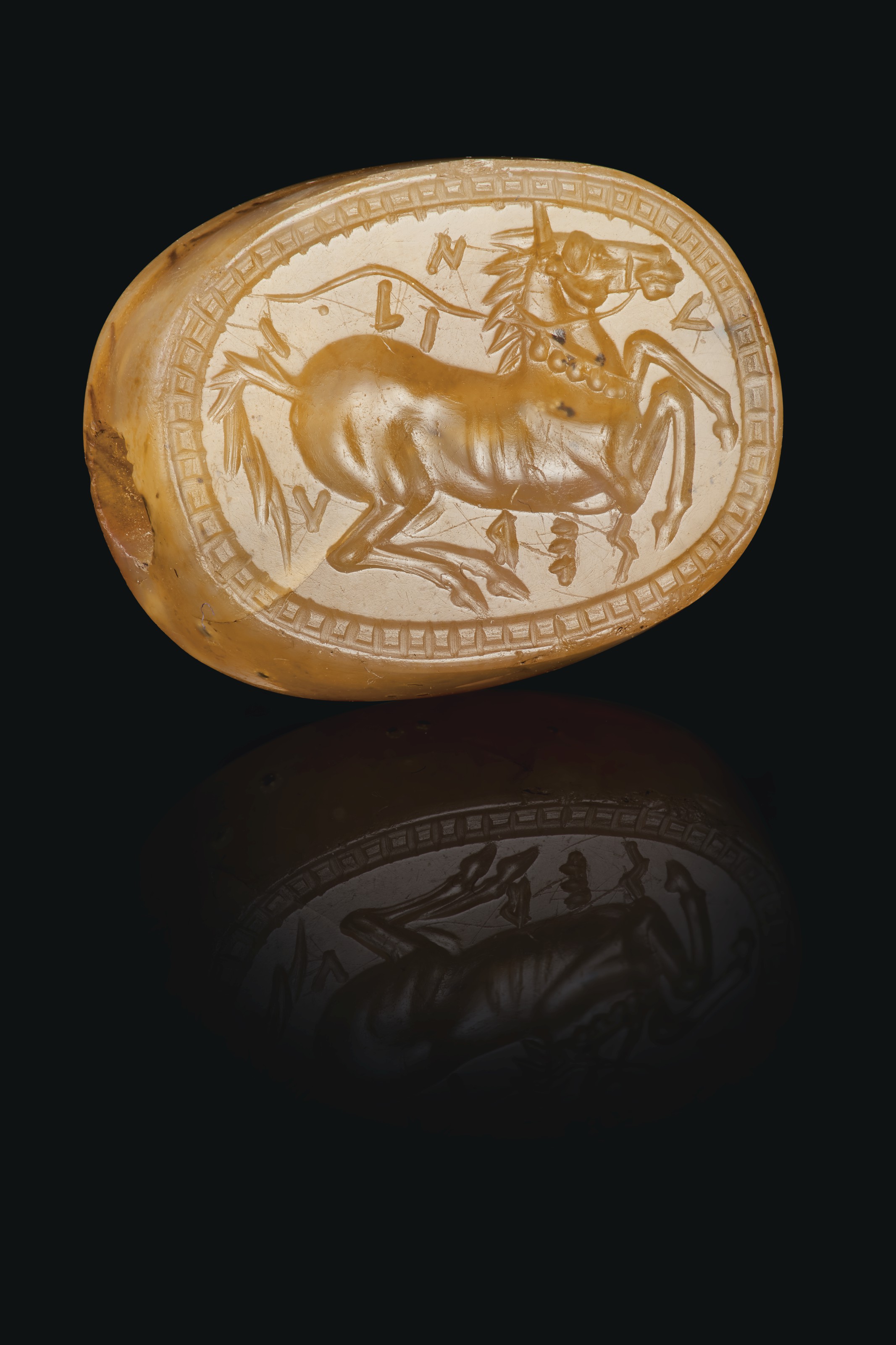A GREEK CARNELIAN SCARAB WITH A NUDE ARCHER, ARCHAIC PERIOD, CIRCA ...