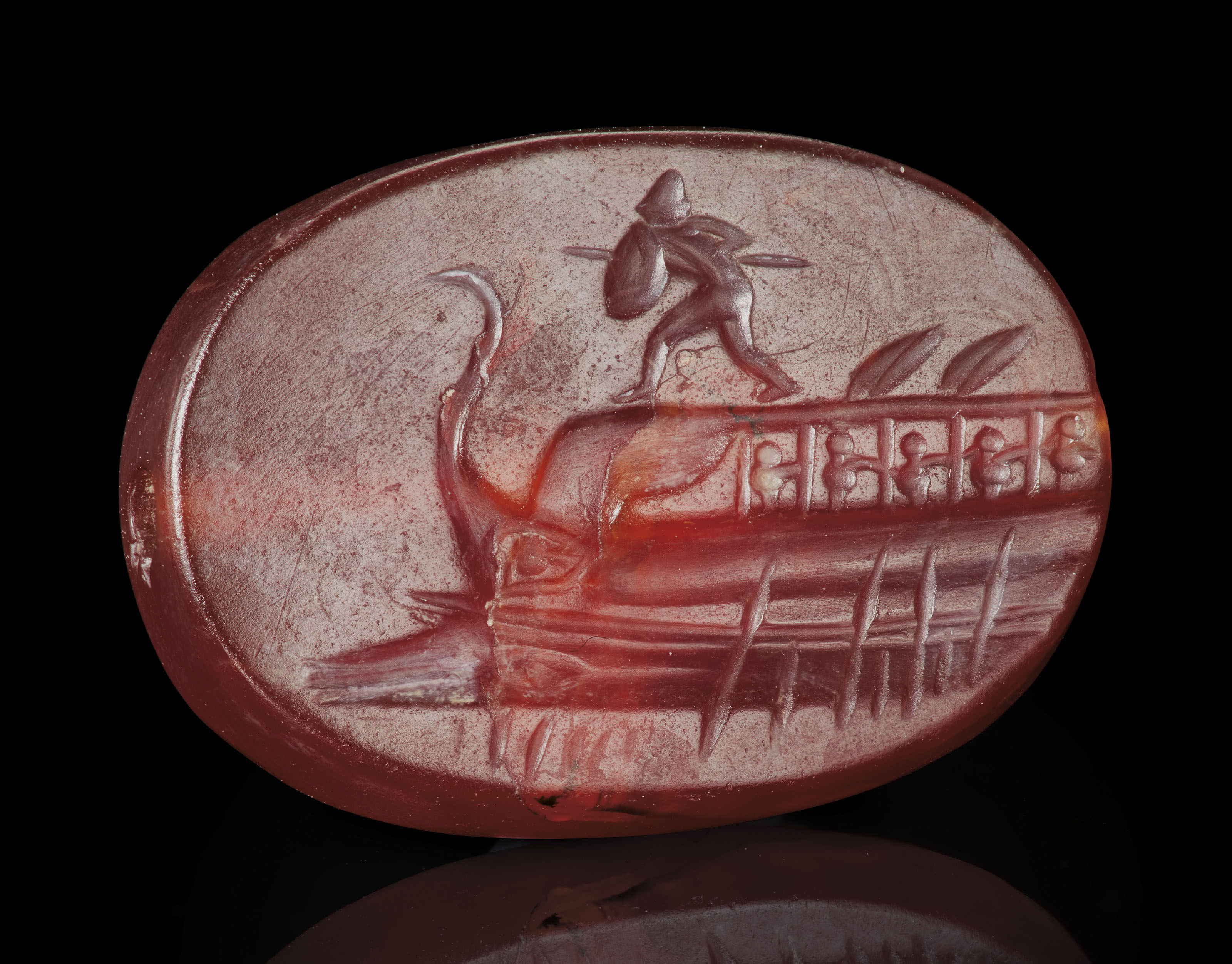 A GREEK CARNELIAN SCARAB WITH A NUDE ARCHER, ARCHAIC PERIOD, CIRCA ...