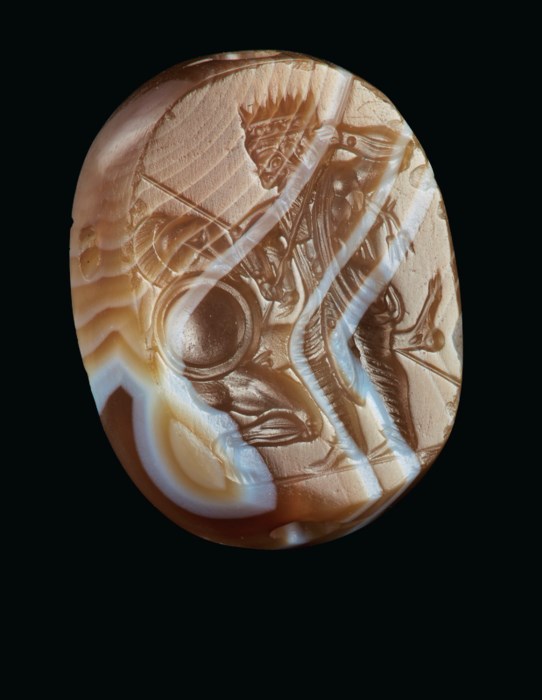 A GRECO-PERSIAN BANDED AGATE SCARABOID WITH A COMBAT SCENE