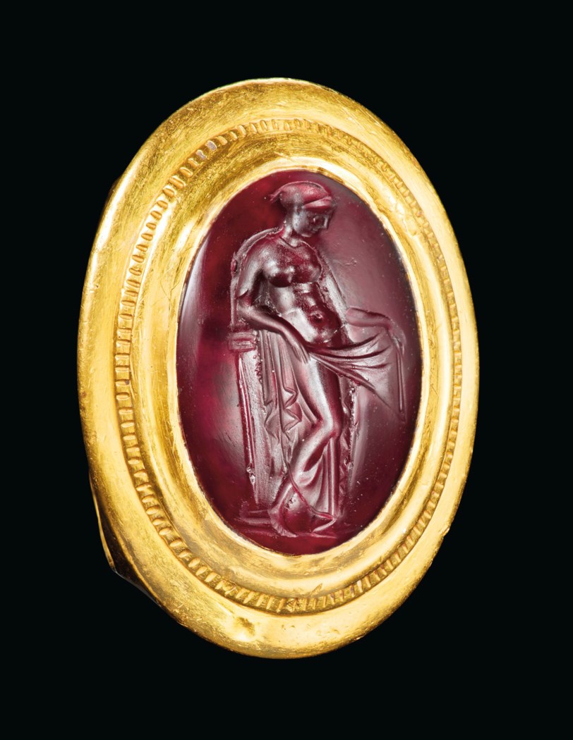 A GREEK GOLD AND GARNET FINGER RING WITH DANAE, HELLENISTIC PERIOD ...