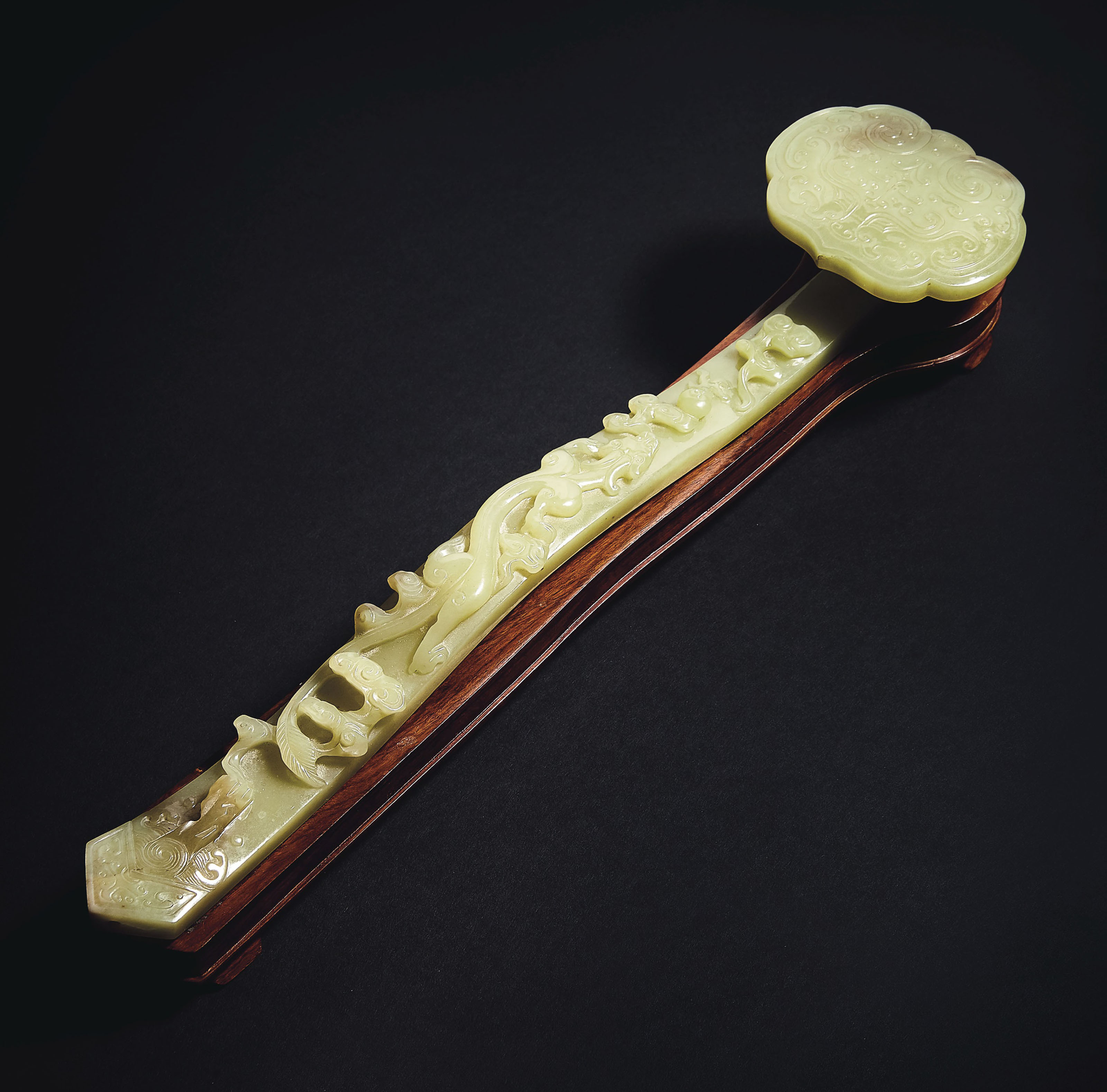 A YELLOWISH-GREEN JADE RUYI SCEPTER