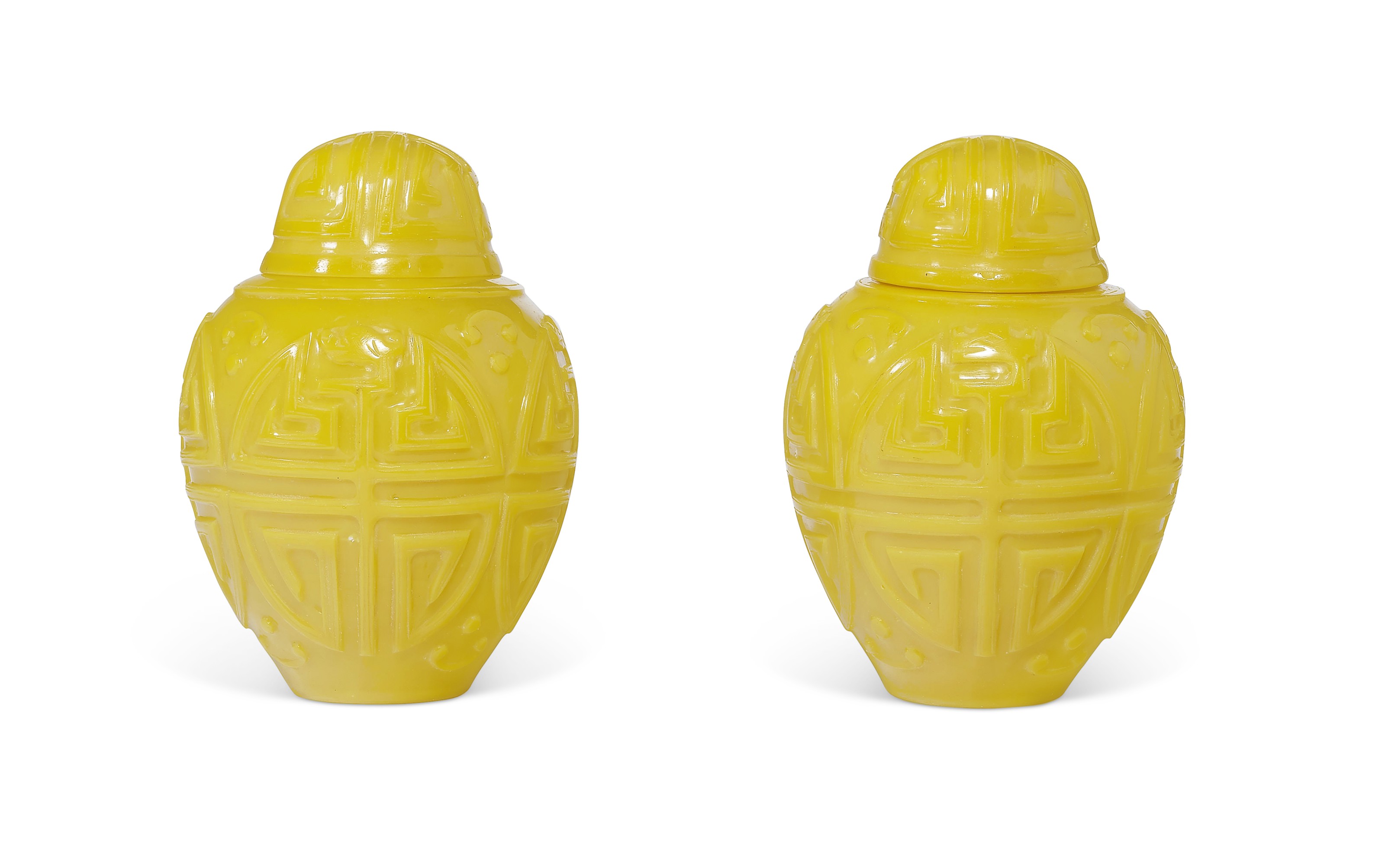 A PAIR OF CARVED YELLOW GLASS JARS AND COVERS, 19TH CENTURY | Christie’s