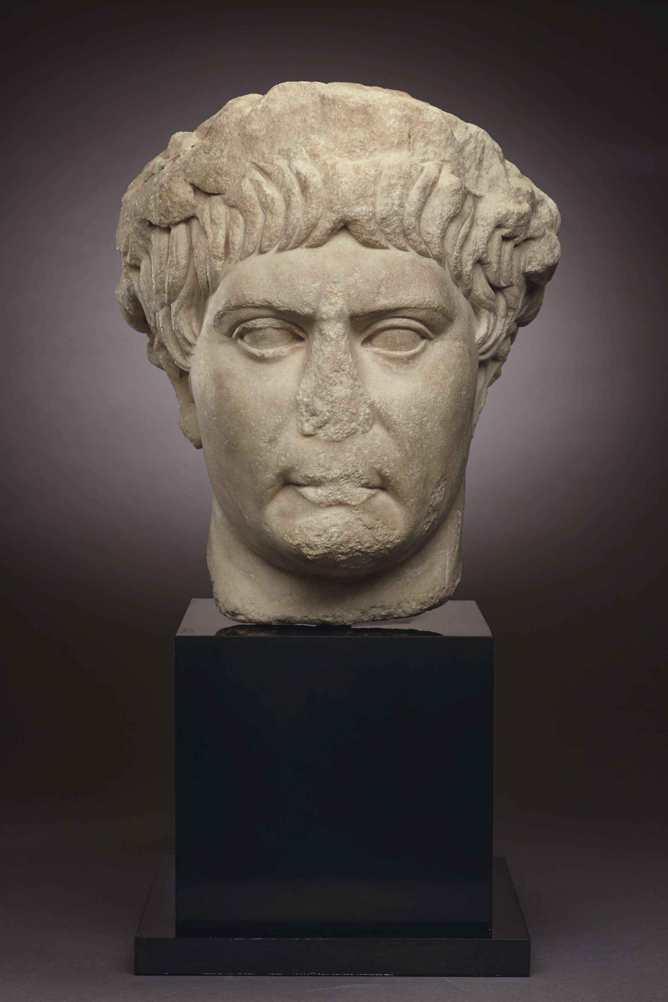 A MONUMENTAL ROMAN MARBLE PORTRAIT HEAD OF THE EMPEROR TRAJAN
