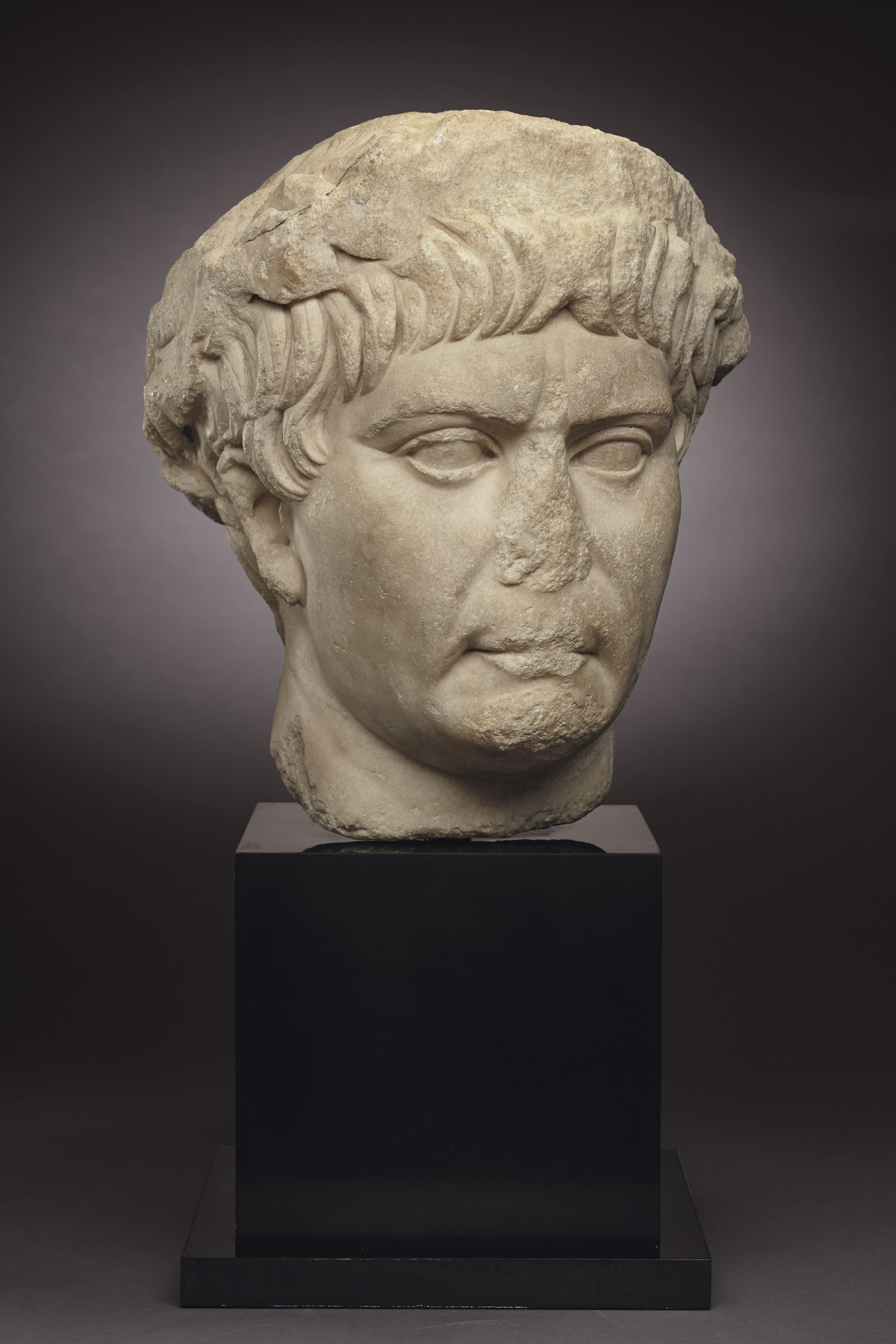 A MONUMENTAL ROMAN MARBLE PORTRAIT HEAD OF THE EMPEROR TRAJAN
