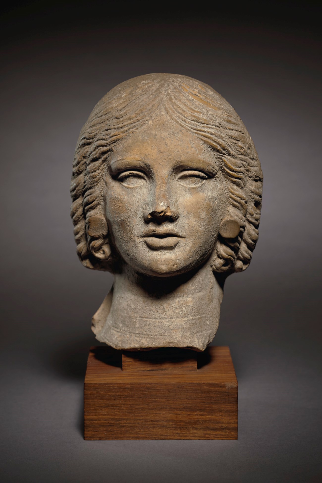 A GREEK TERRACOTTA FEMALE HEAD, TARENTINE, HELLENISTIC PERIOD, CIRCA ...