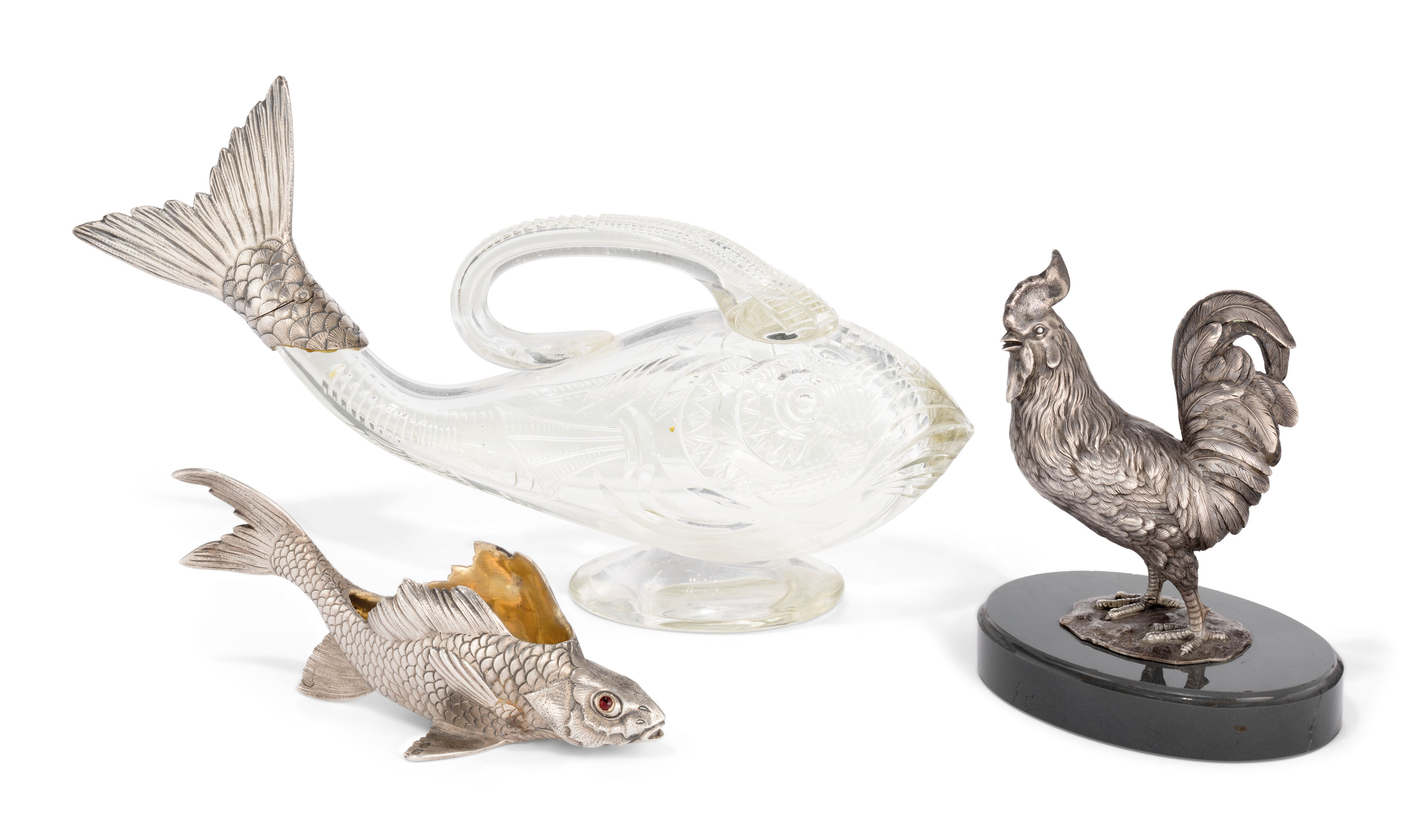 A SILVER-MOUNTED CUT-GLASS FISH-FORM CLARET JUG, A GEM-SET SILVER FISH ...