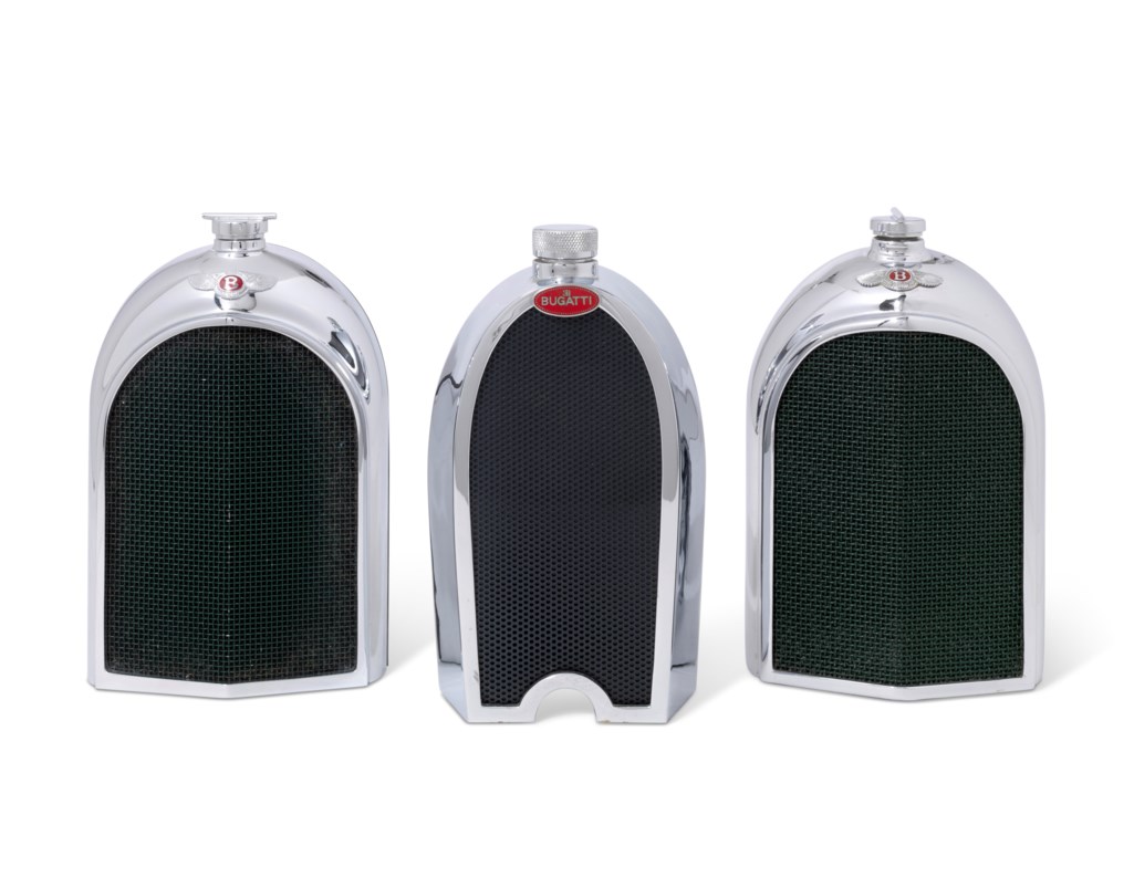 A GROUP OF NINE CHROMIUM-PLATED NOVELTY FLASKS, MOST BY RUDDSPEED ...