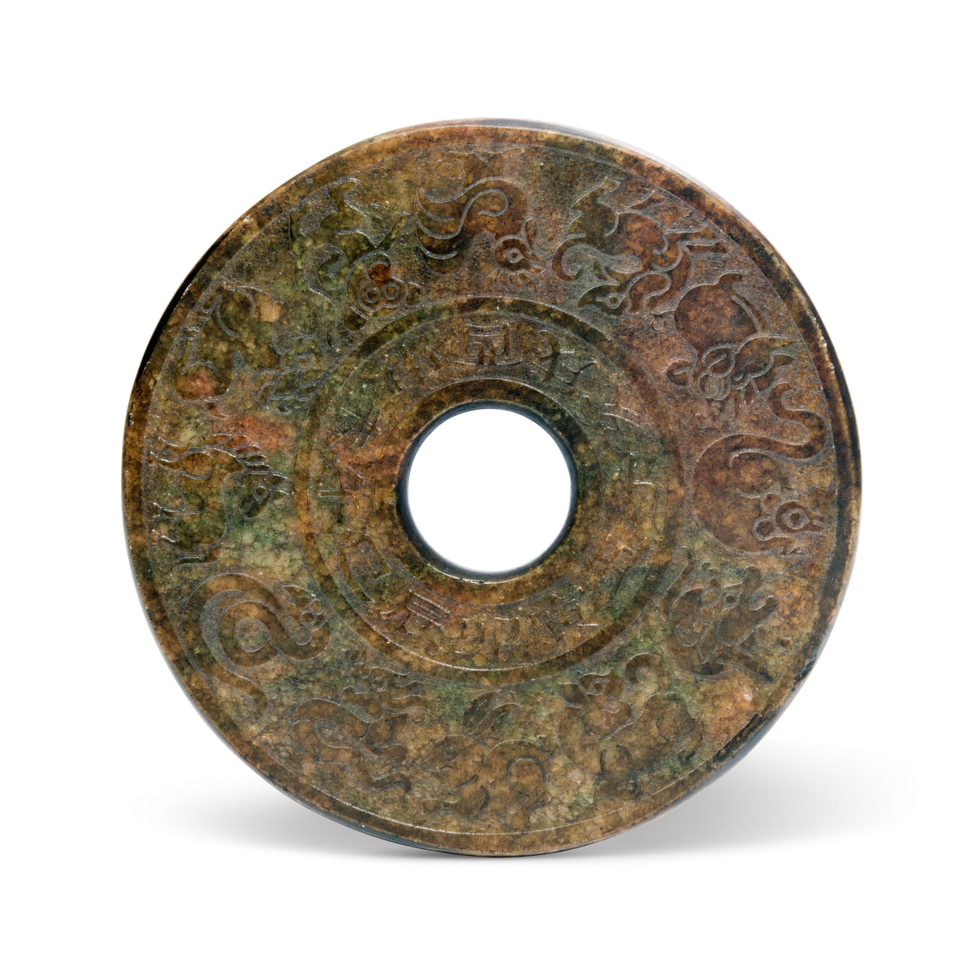 A CHINESE MOTTLED GREEN AND RUSSET JADE 'ZODIAC' DISC, BI, 19TH-20TH ...