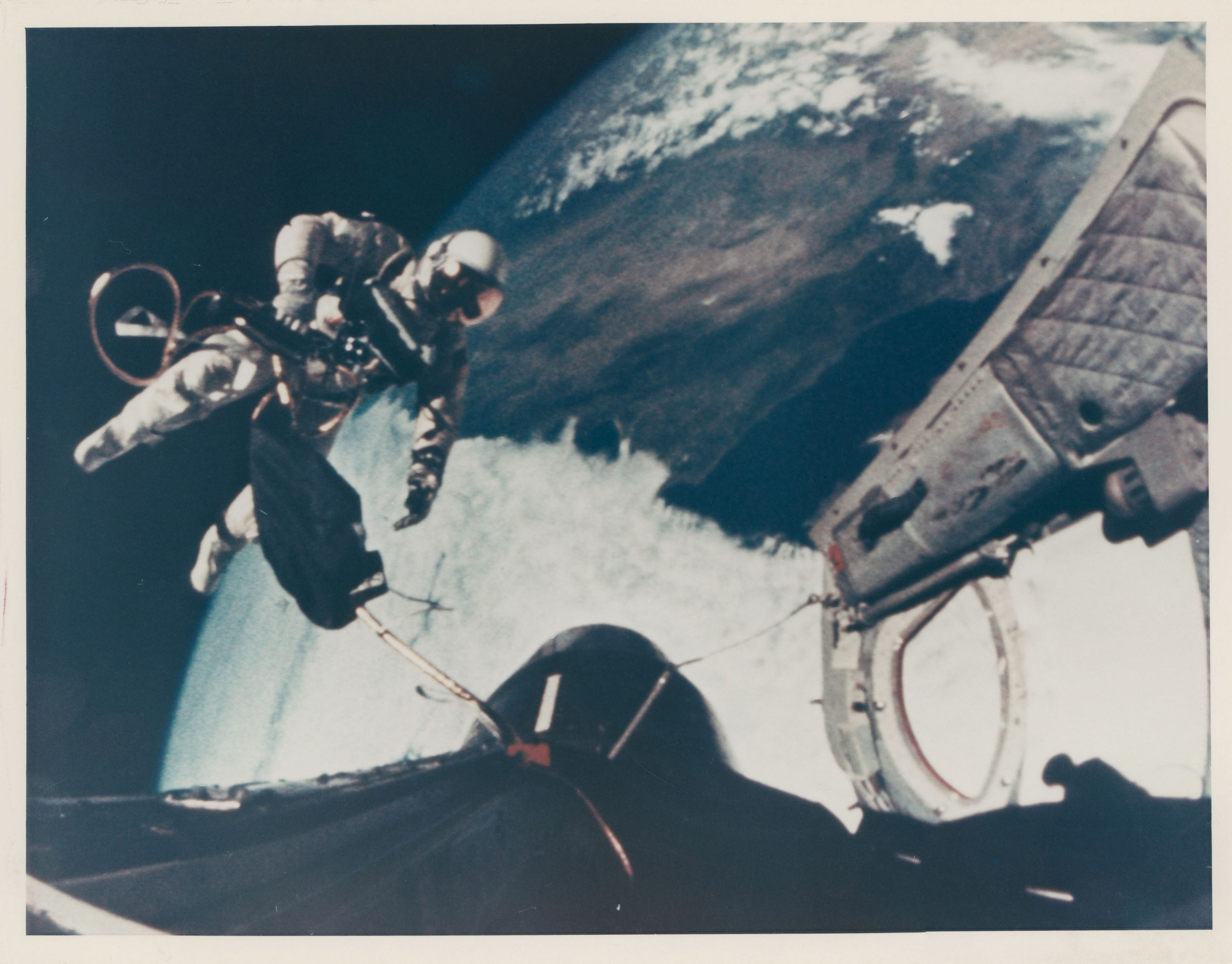 First US Spacewalk: views of Ed White returning to the spacecraft at ...